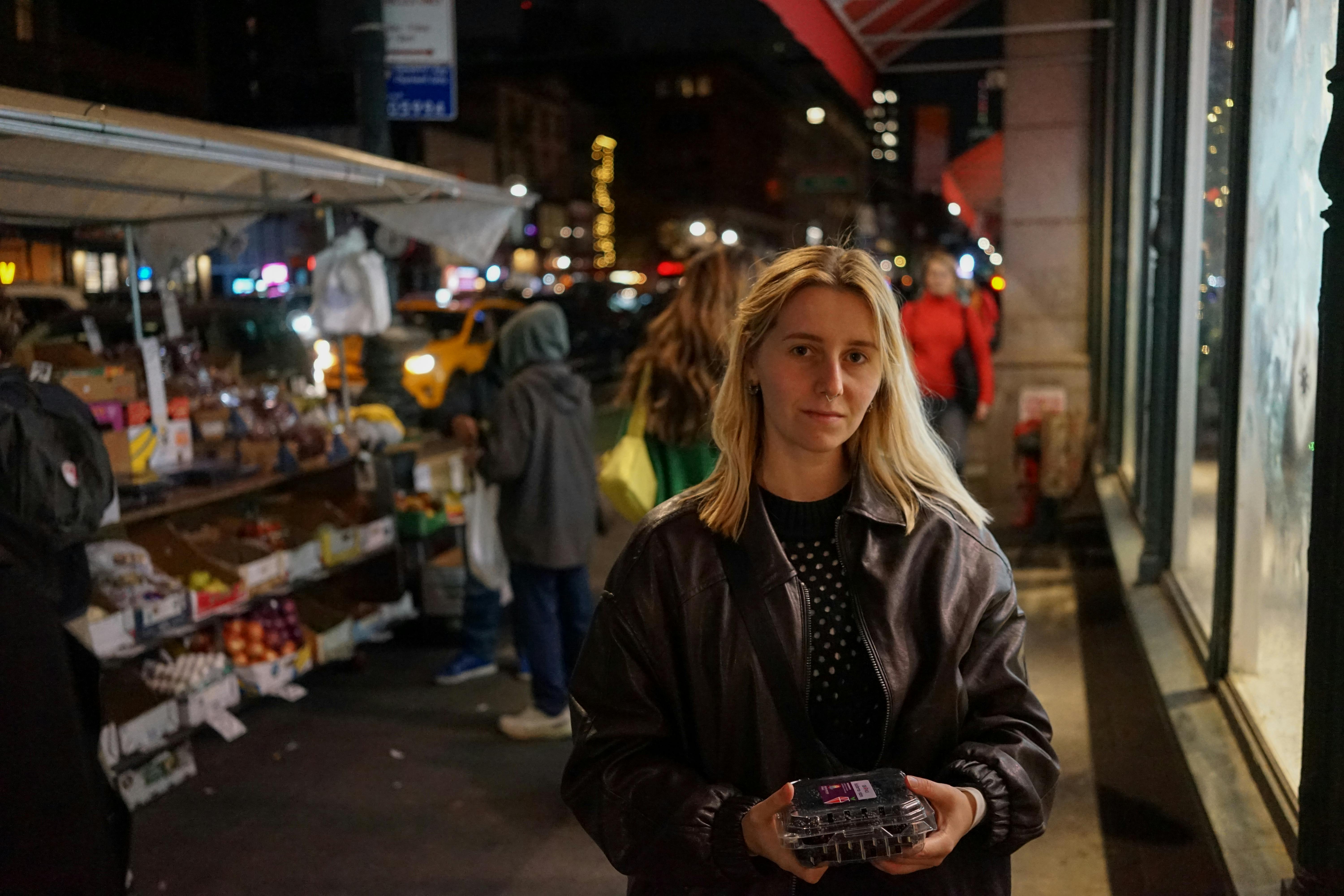 Night Street Market with Shopper Holding Produce · Free Stock Photo