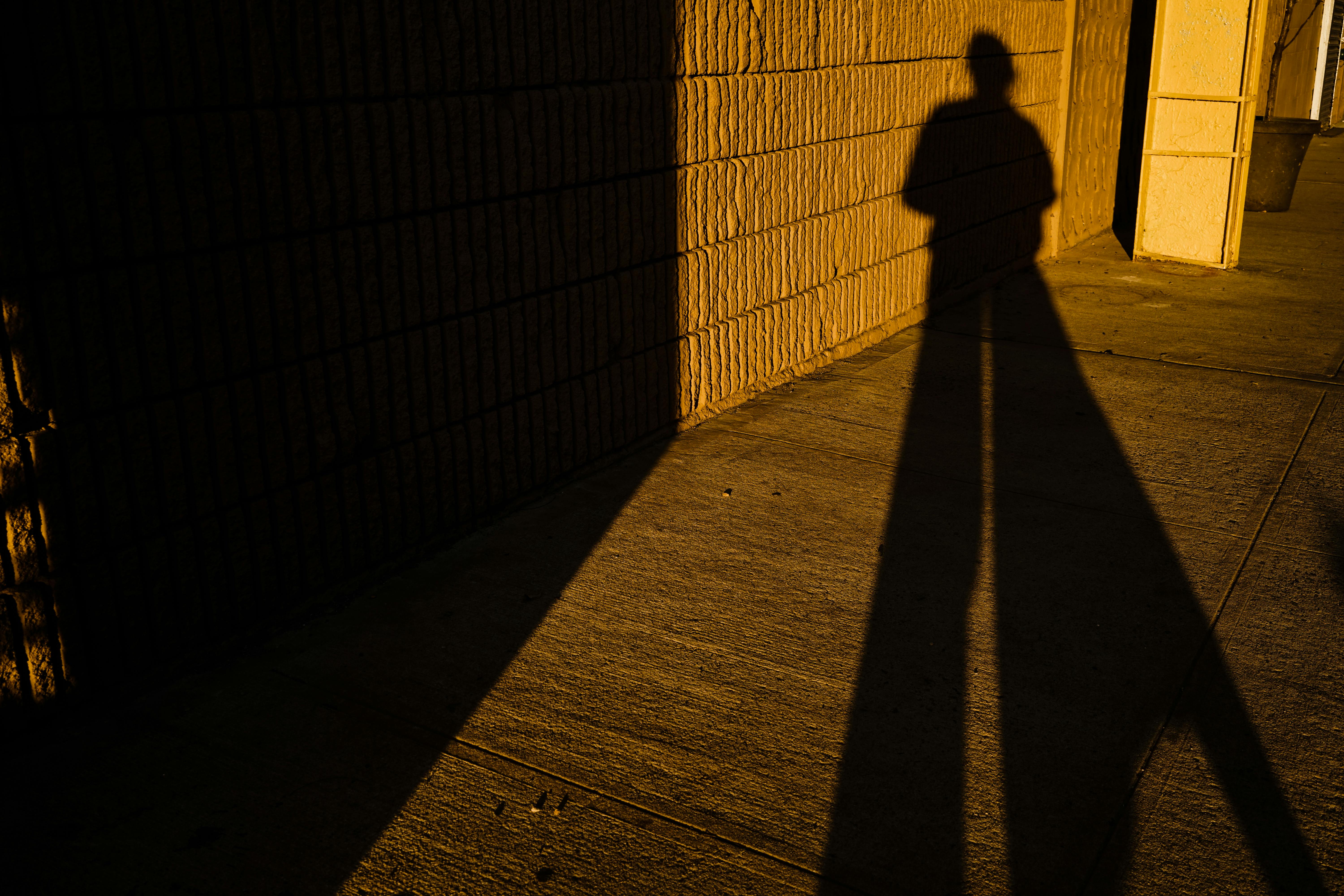 Cinematic Shadow on Urban Sidewalk at Sunset · Free Stock Photo