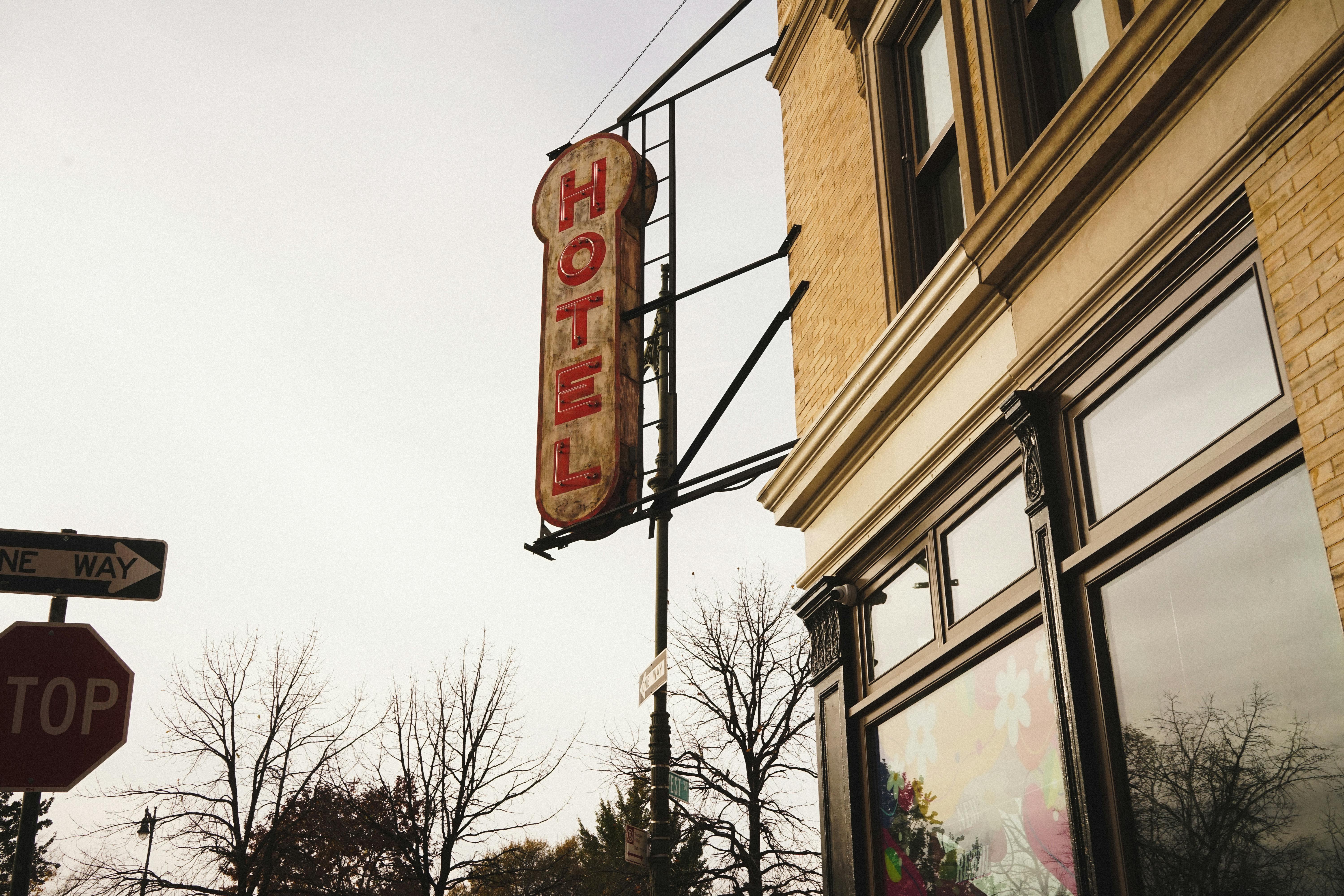 Vintage Hotel Sign on Urban Street Corner · Free Stock Photo