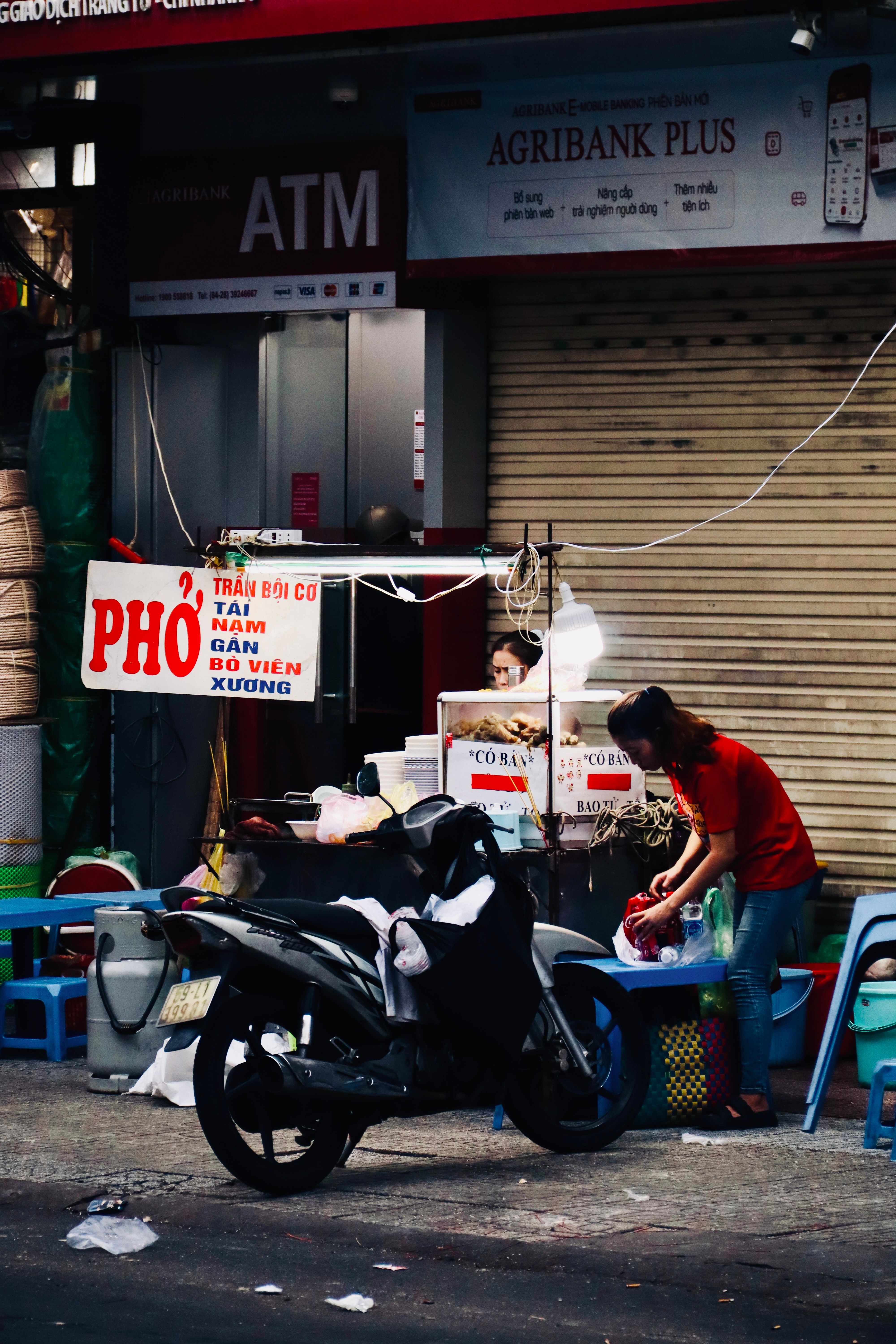 Street Vendor Preparing Pho with Motorbike in View · Free Stock Photo