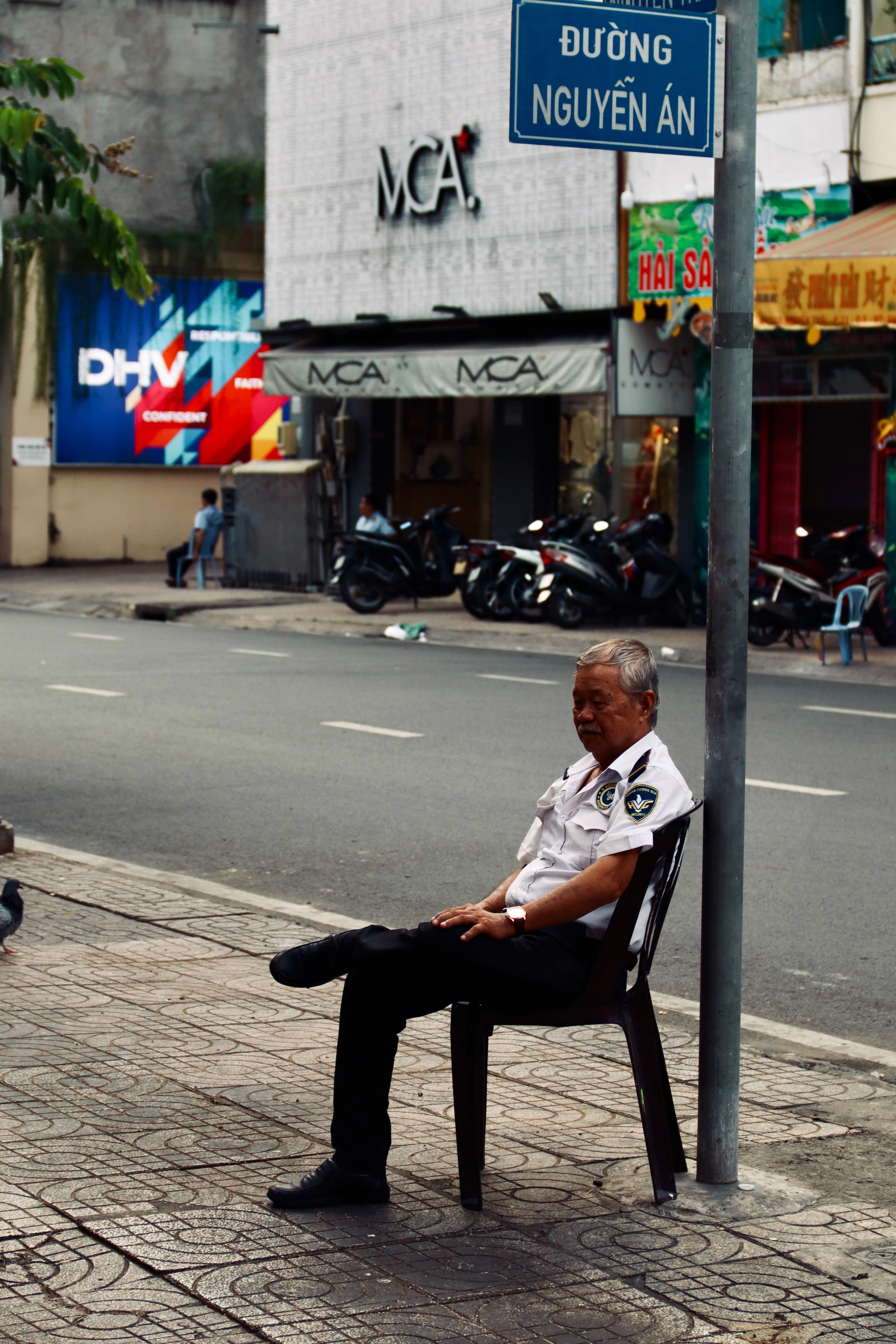 Urban Scene with Resting Security Guard on Street · Free Stock Photo