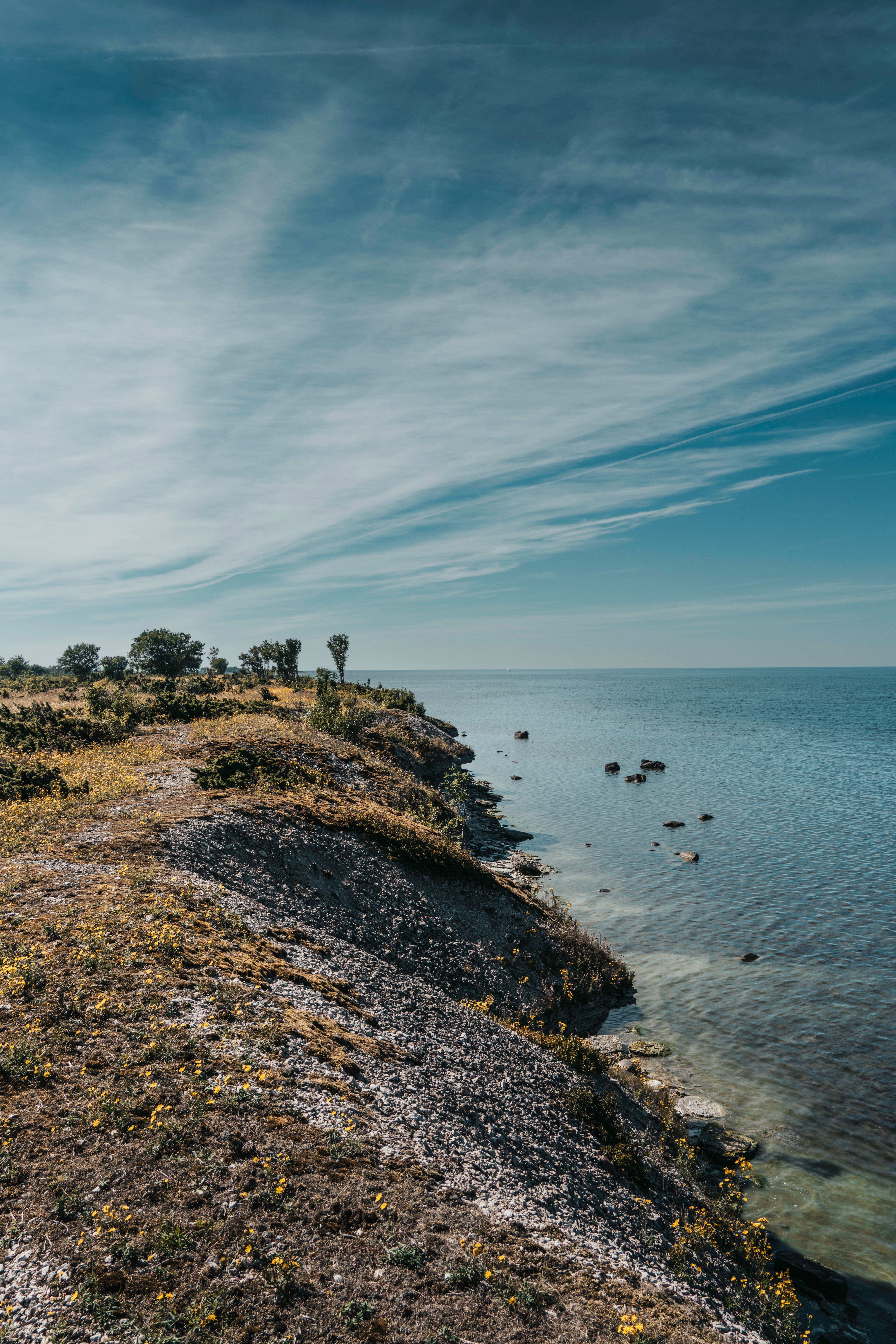 Scenic Coastal Cliff View with Clear Blue Sky · Free Stock Photo
