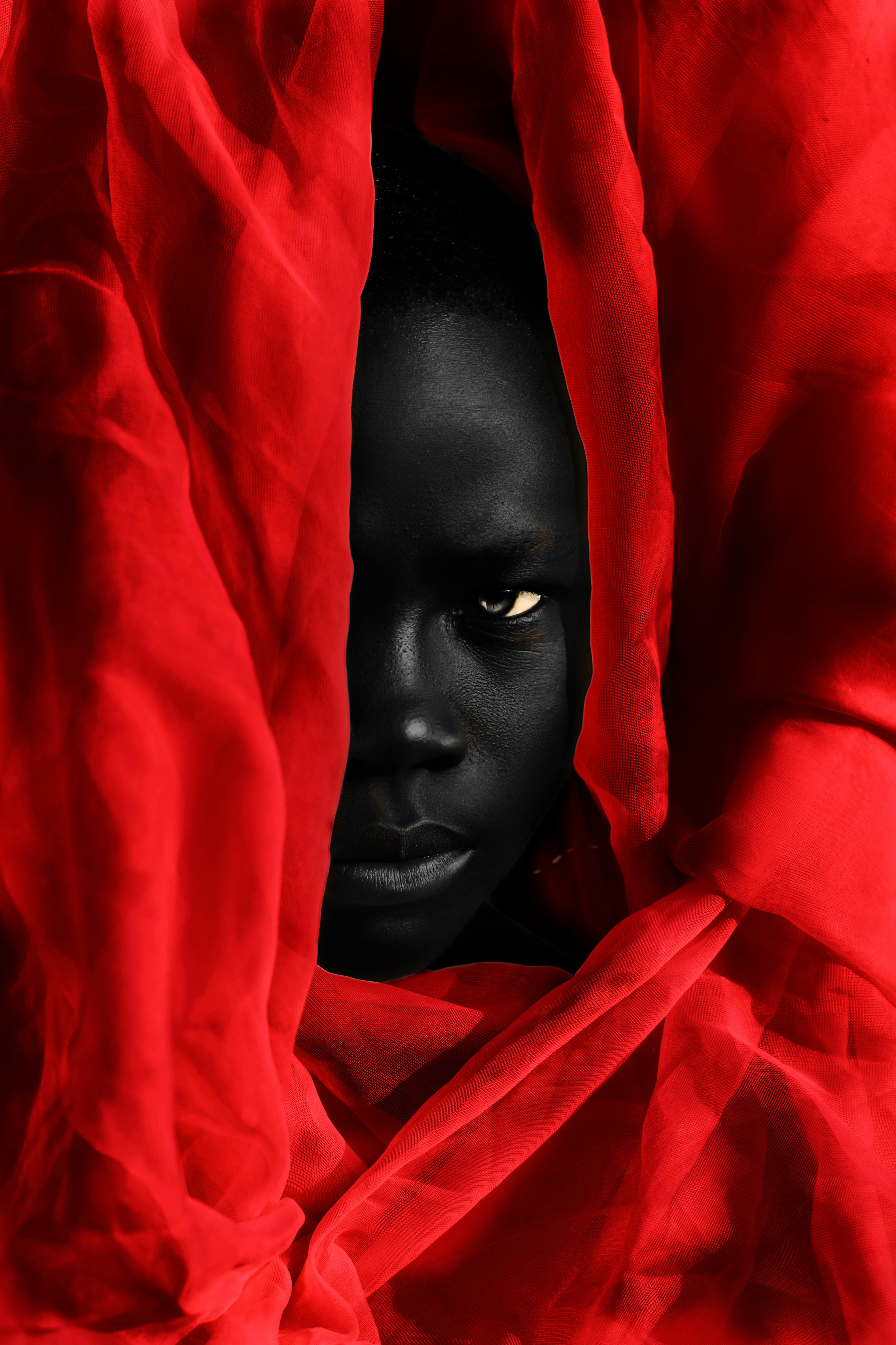 Dramatic Portrait of Person in Red Fabric · Free Stock Photo