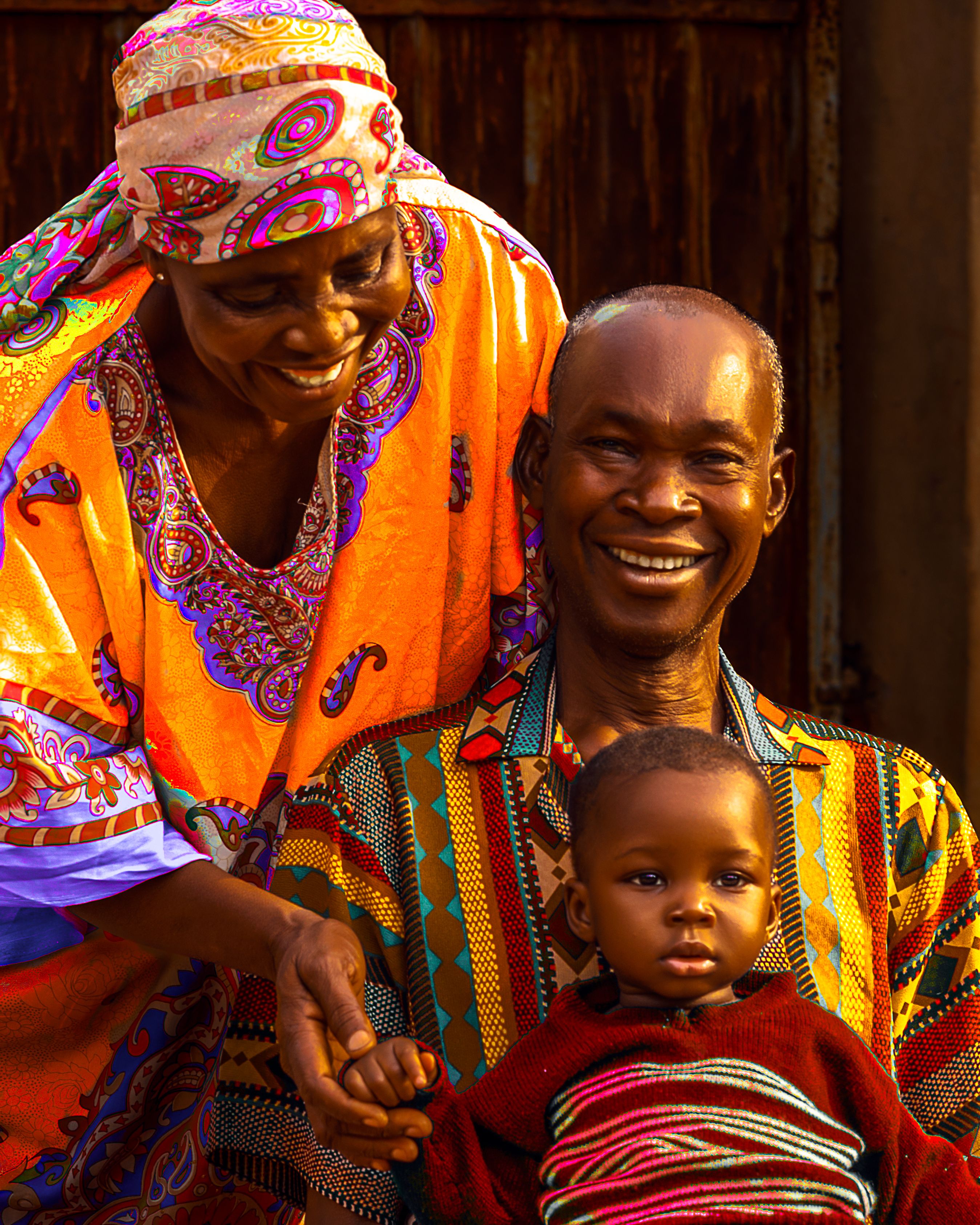 Happy Family in Colorful Traditional Attire · Free Stock Photo