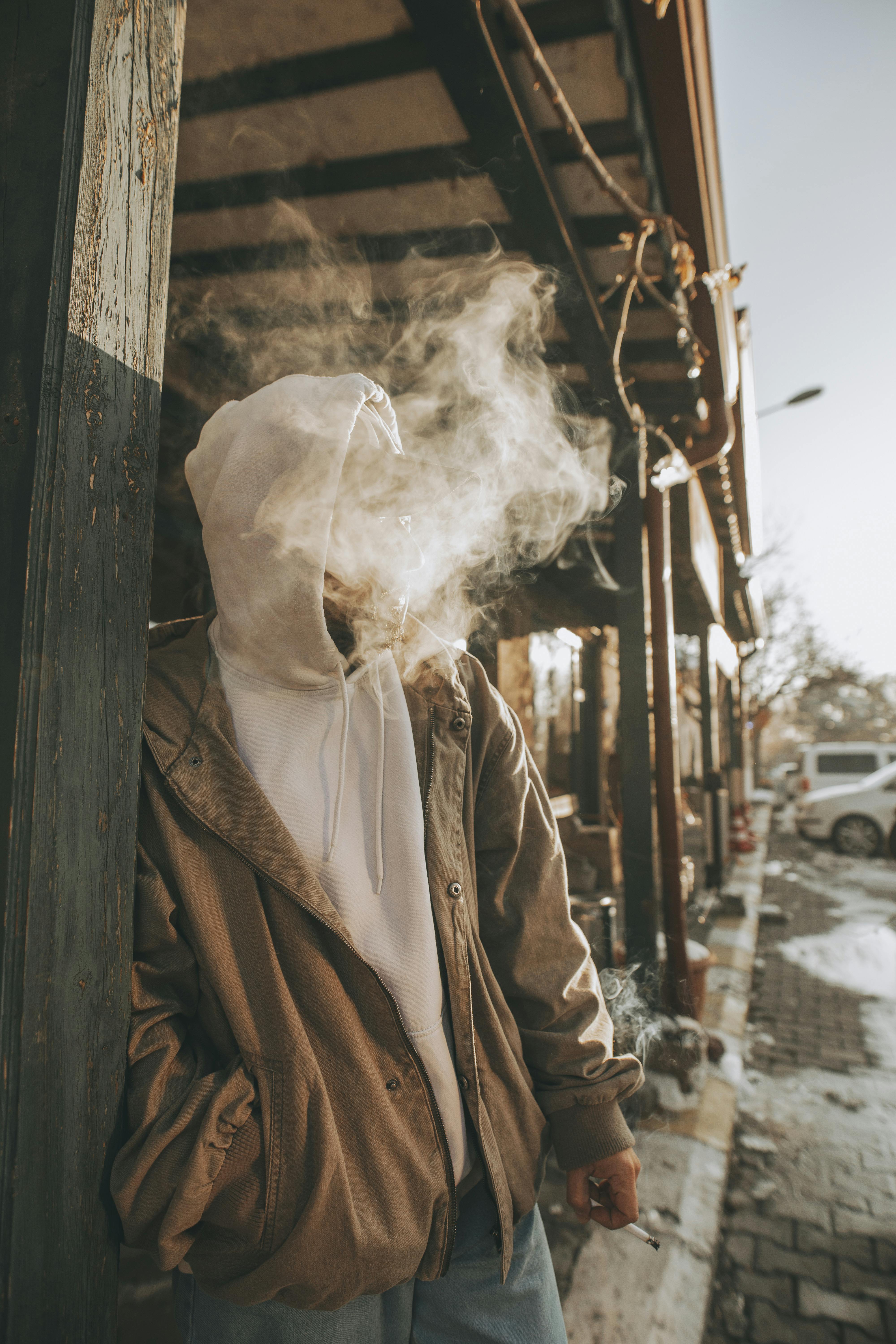 Young Adult Vaping on Urban Street · Free Stock Photo
