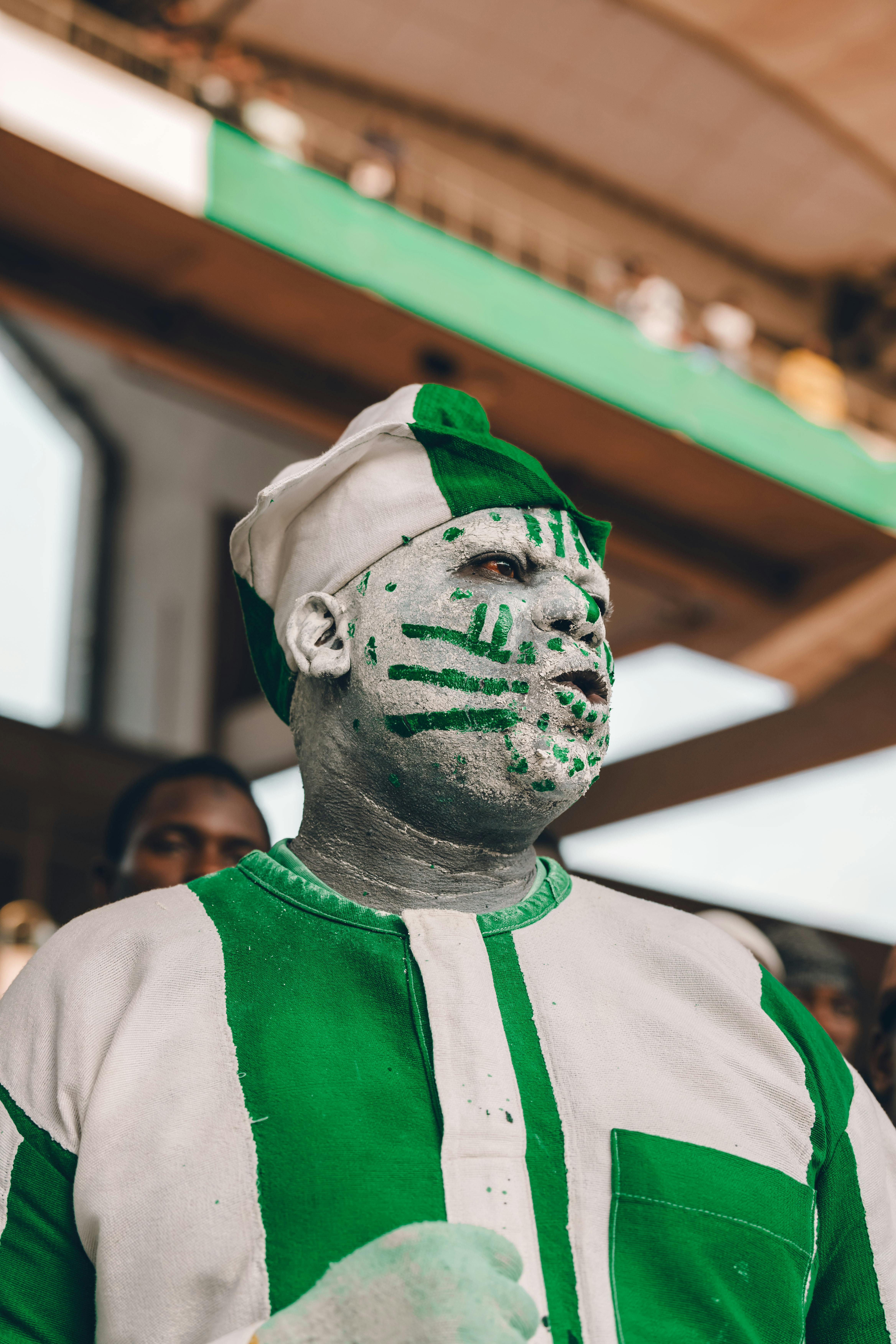 Proud Nigerian Fan in Green and White Face Paint · Free Stock Photo