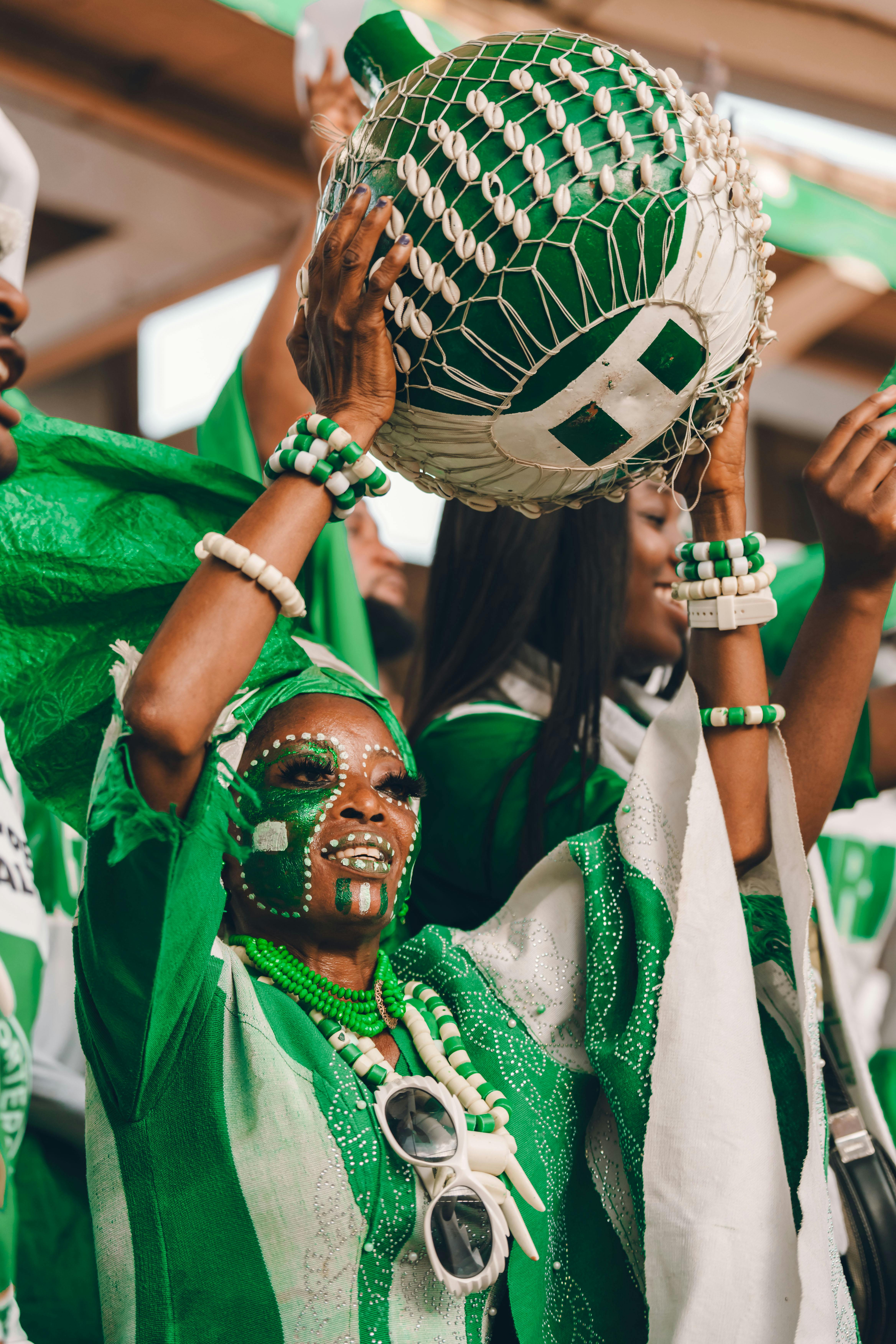 Vibrant Nigerian Fans Celebrating Cultural Festivity · Free Stock Photo