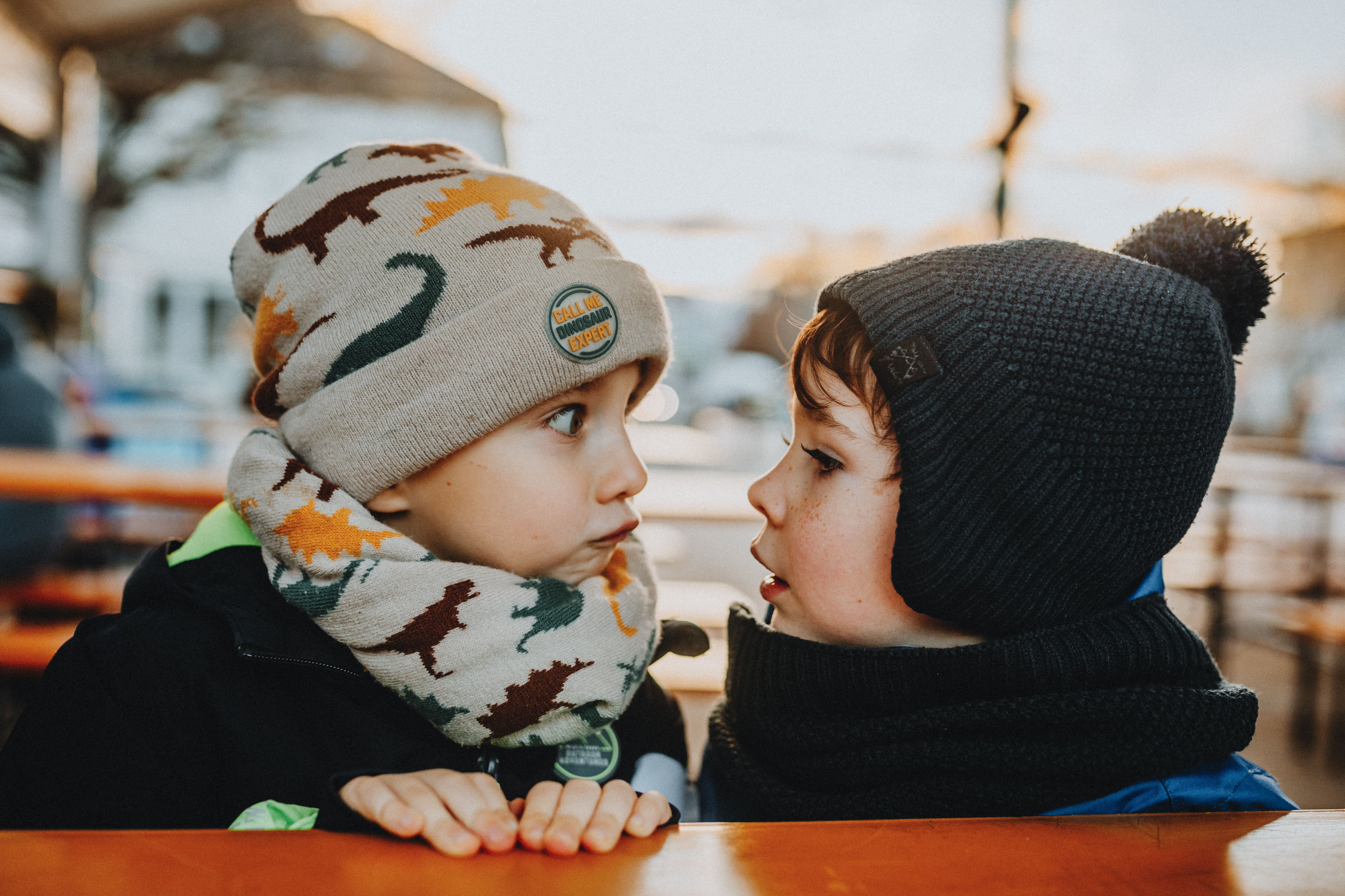 Two Children Conversing in Winter Attire · Free Stock Photo