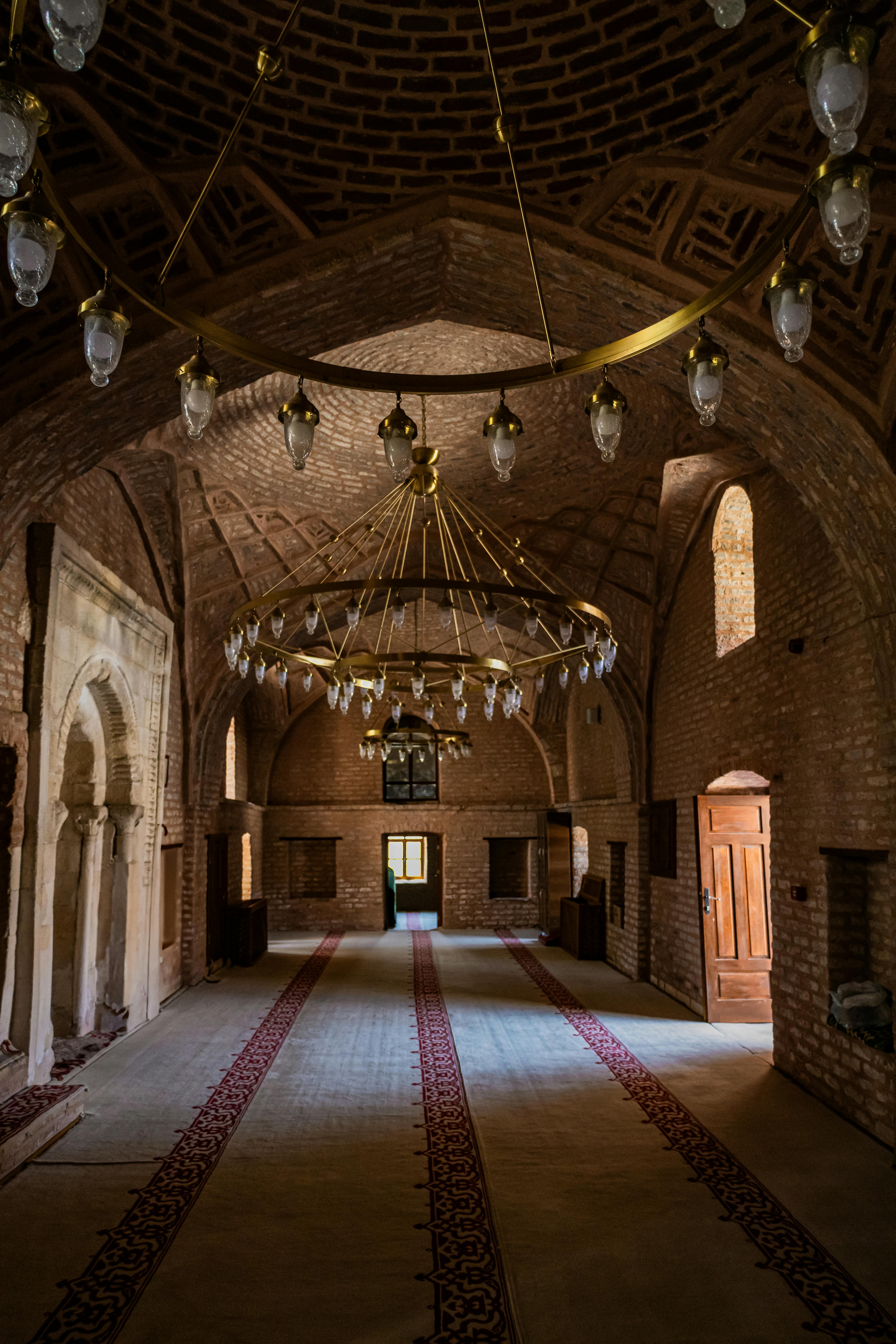 Historic Brick Arched Interior with Chandelier · Free Stock Photo