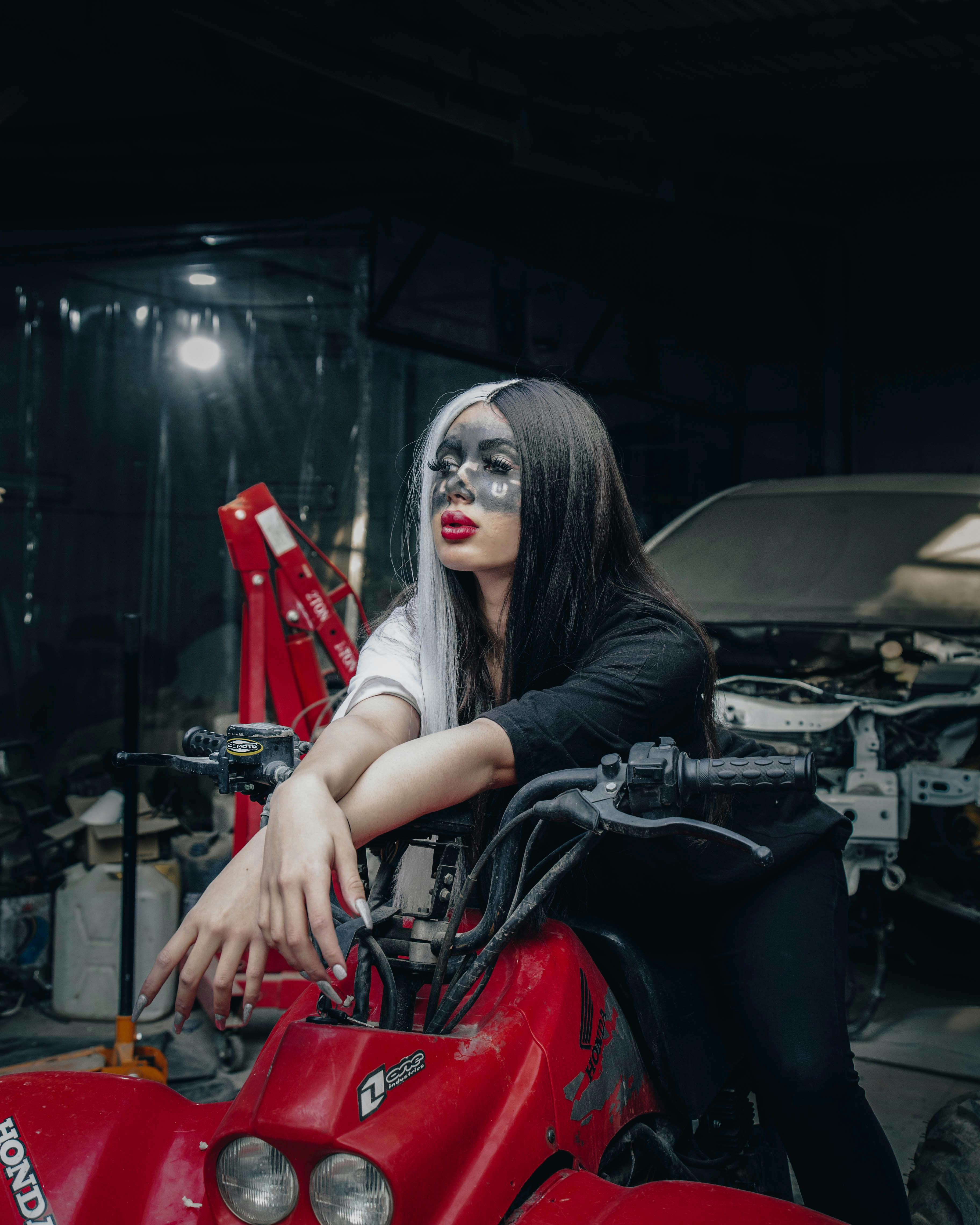 Gothic Woman on Red ATV in Garage Setting · Free Stock Photo
