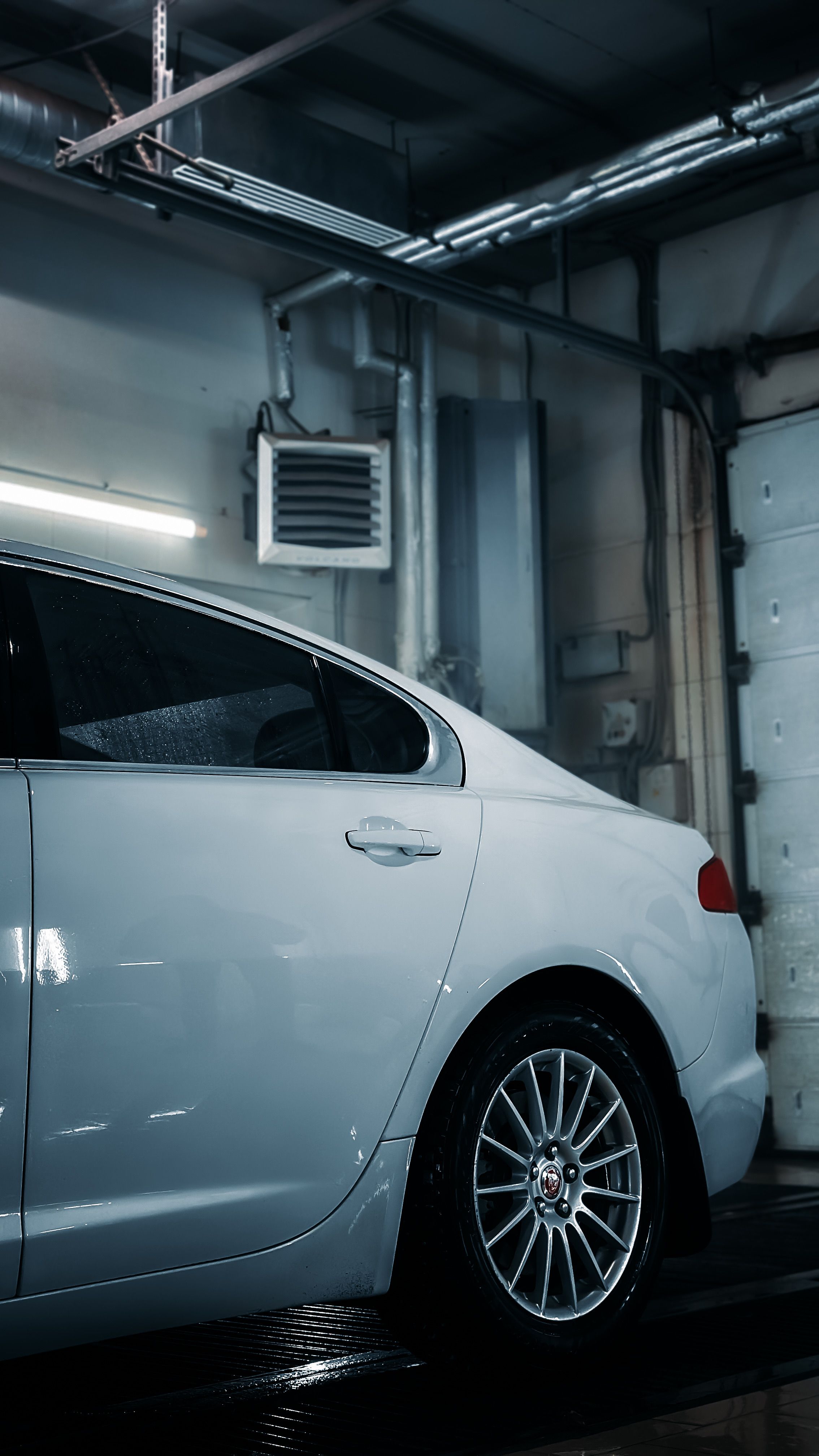 Sleek White Sedan in Indoor Car Wash Facility · Free Stock Photo