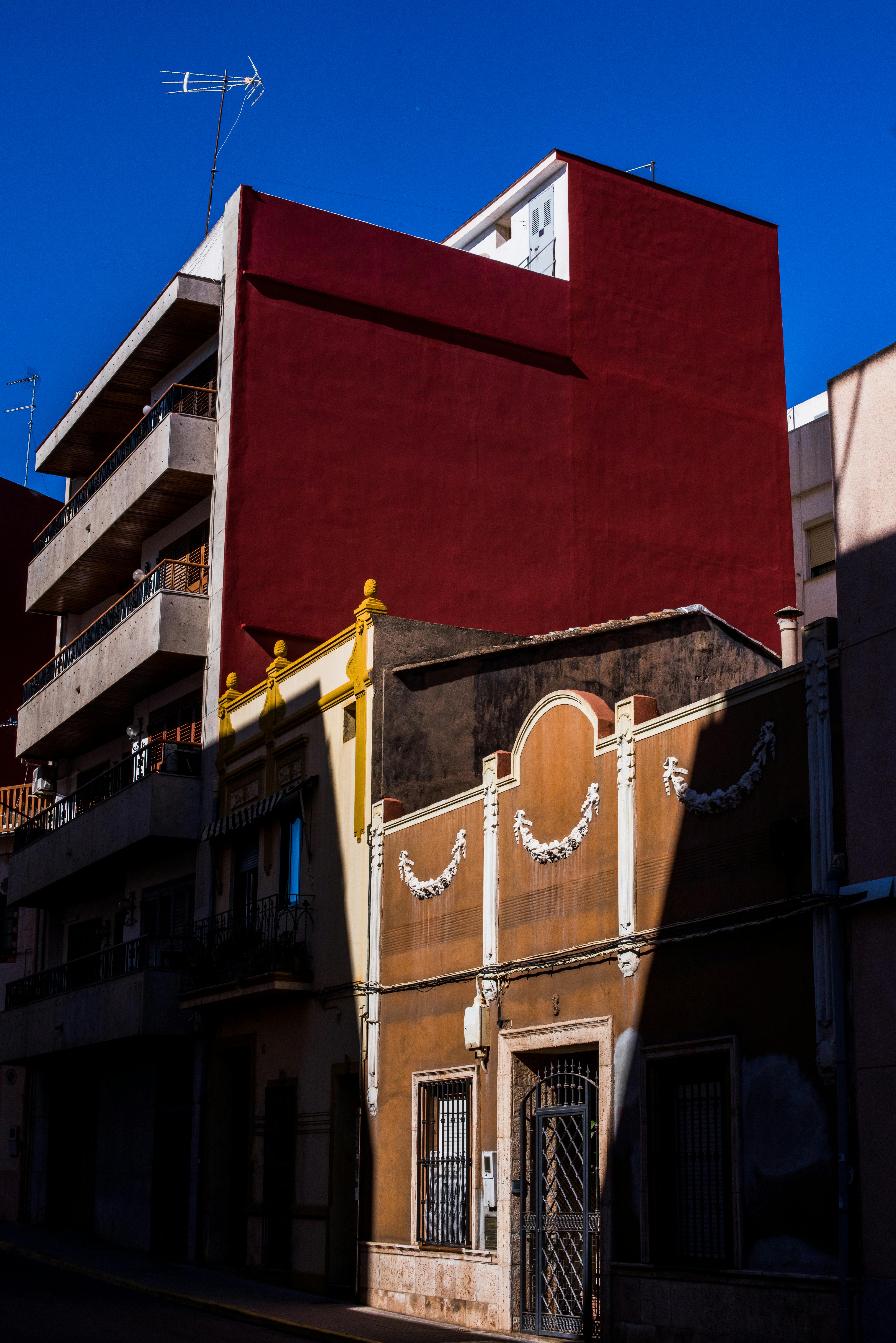 Colorful Urban Building with Shadow Play · Free Stock Photo