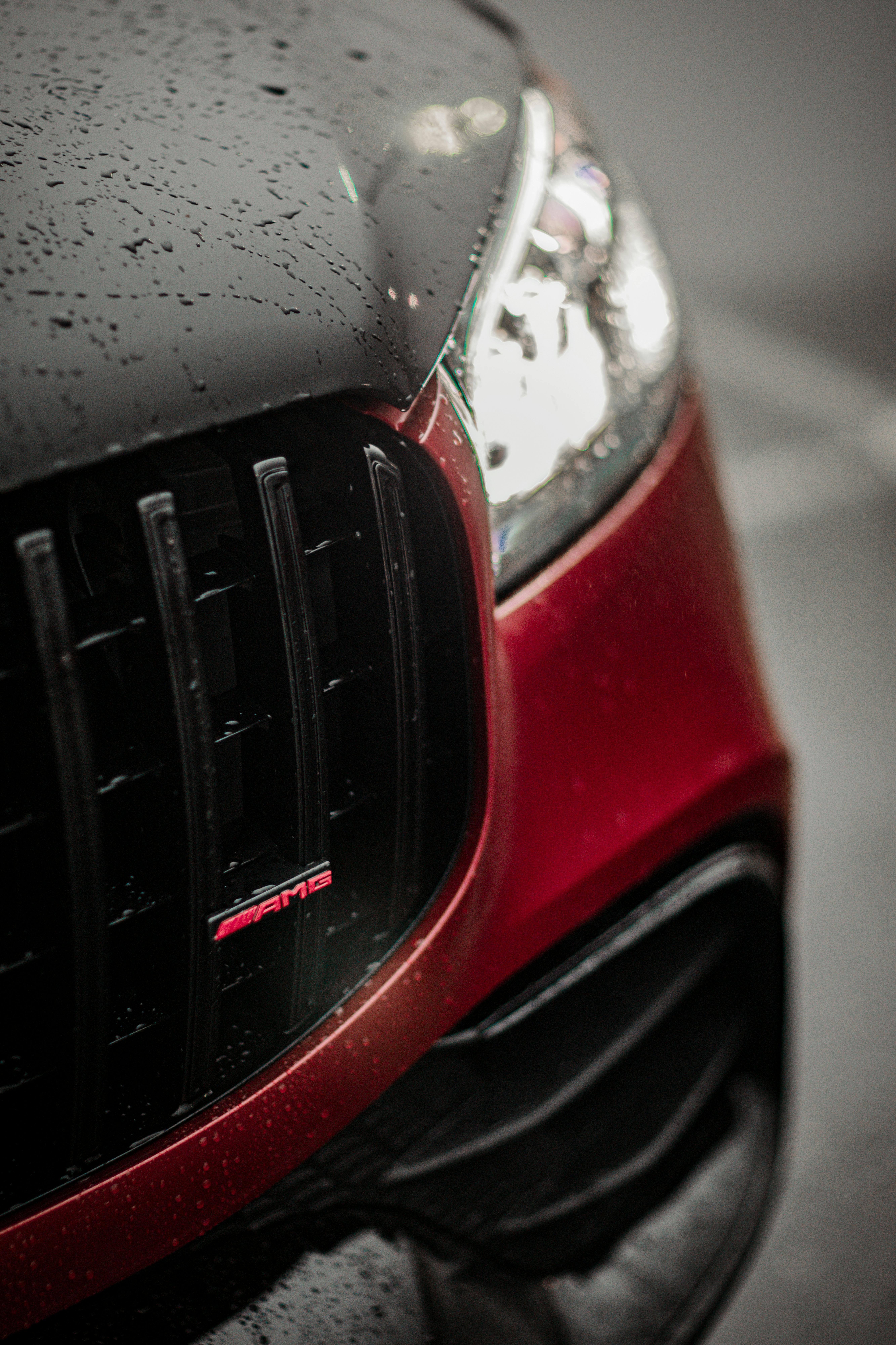 Close-Up of a Luxurious Red Car Front Grille · Free Stock Photo