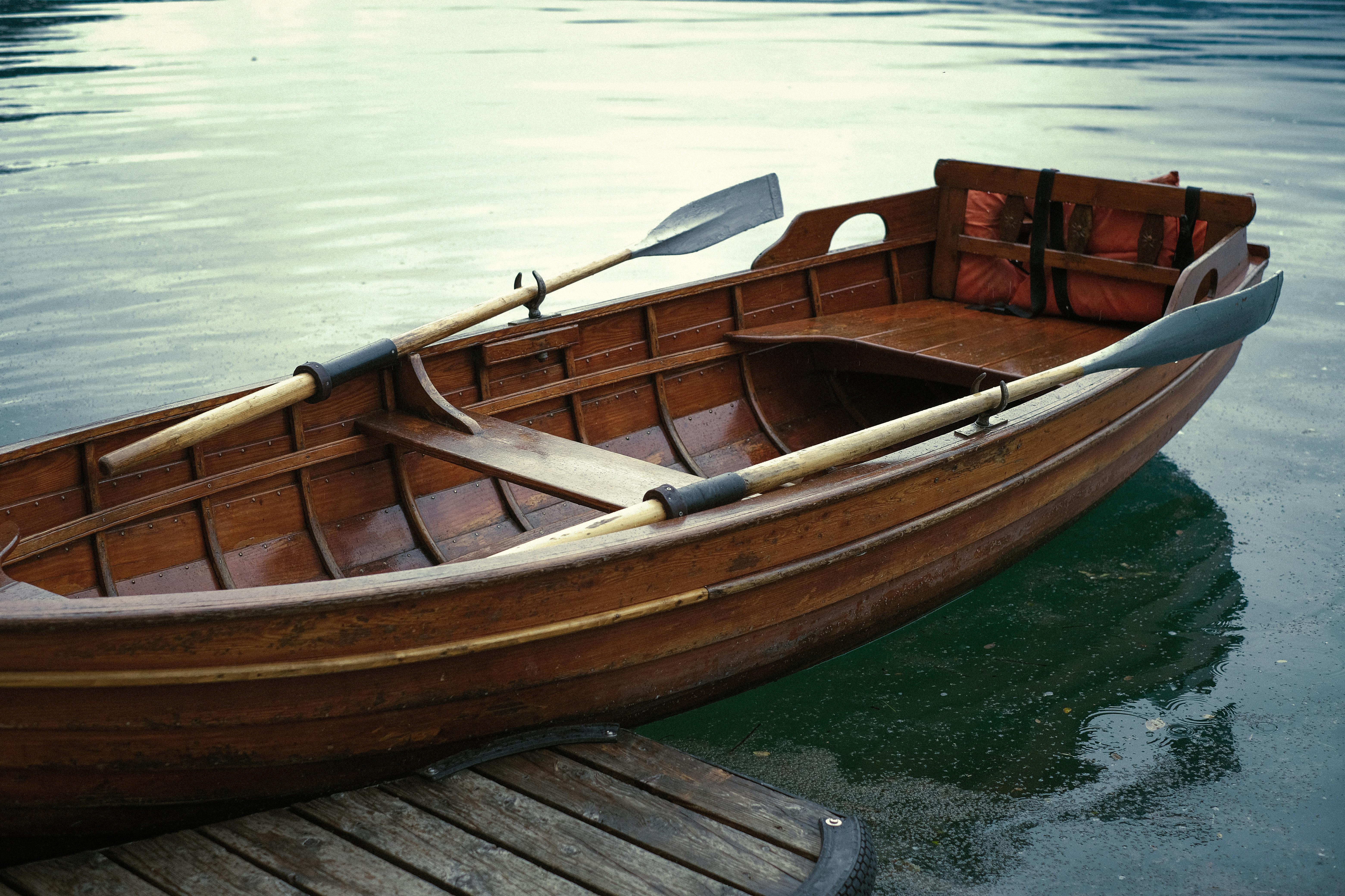 Wooden Rowboat Moored on Serene Lake · Free Stock Photo