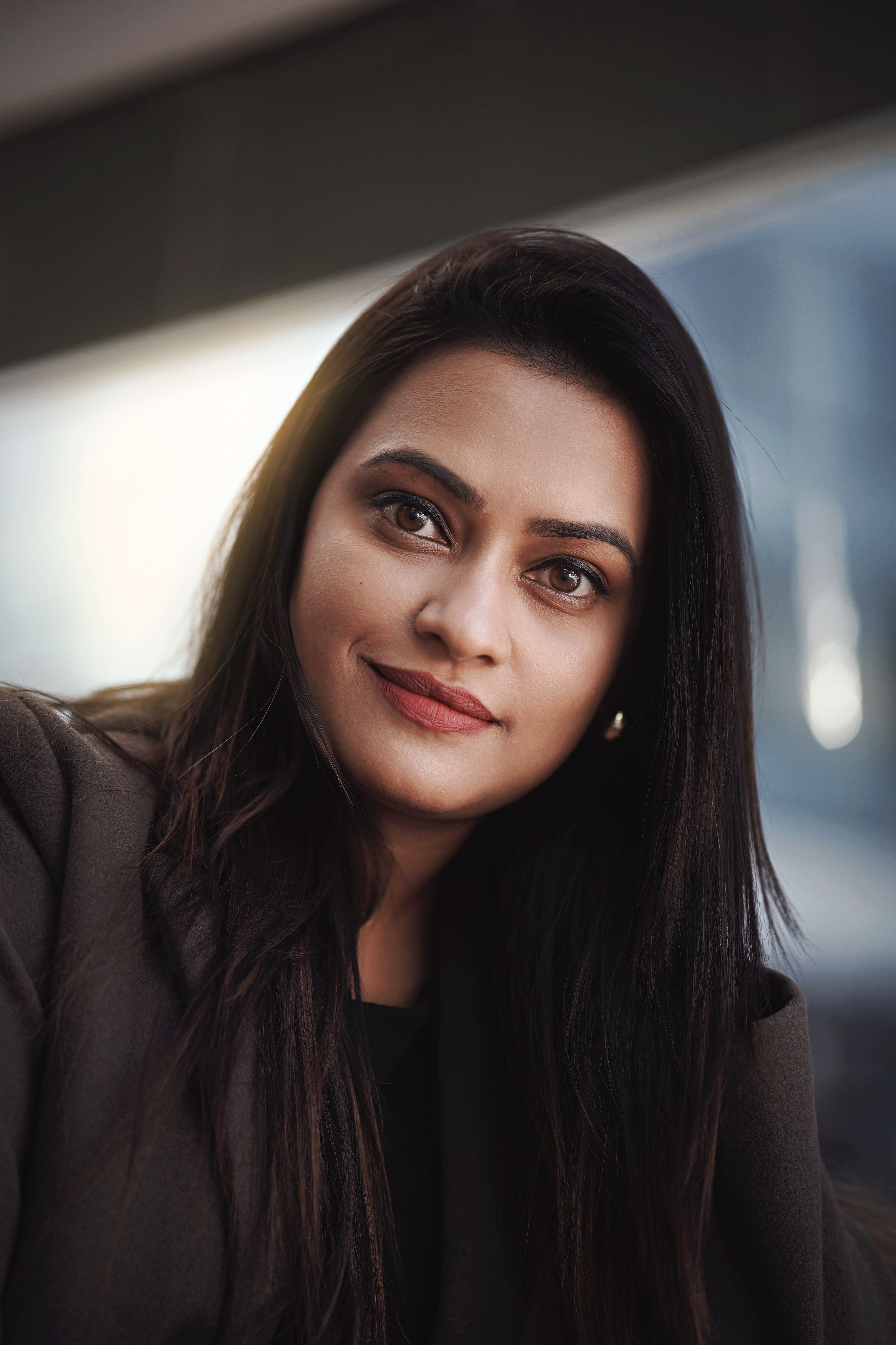 Professional Woman Smiling in Business Attire · Free Stock Photo