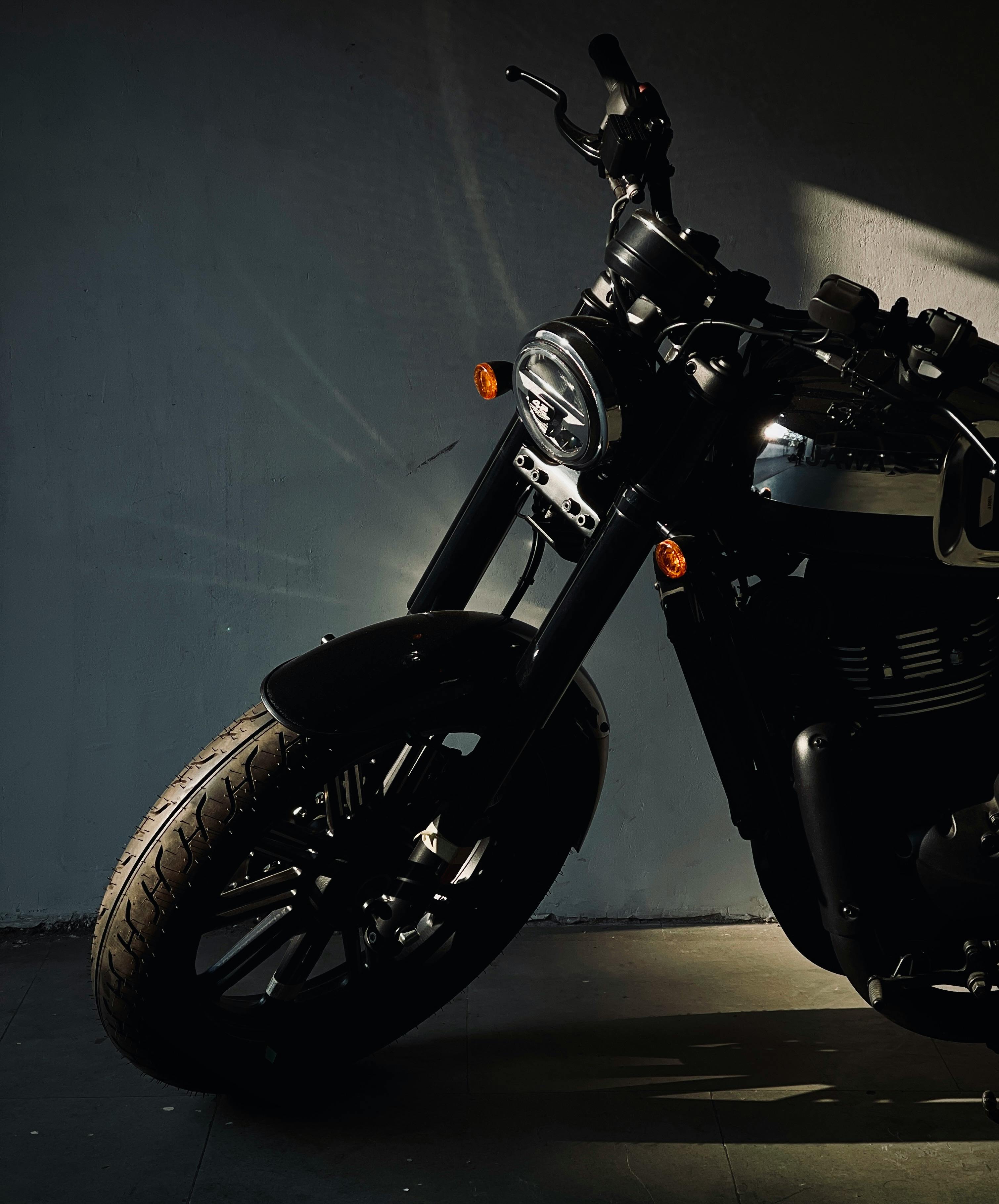 Detailed Side View of Classic Motorcycle in Shadow · Free Stock Photo
