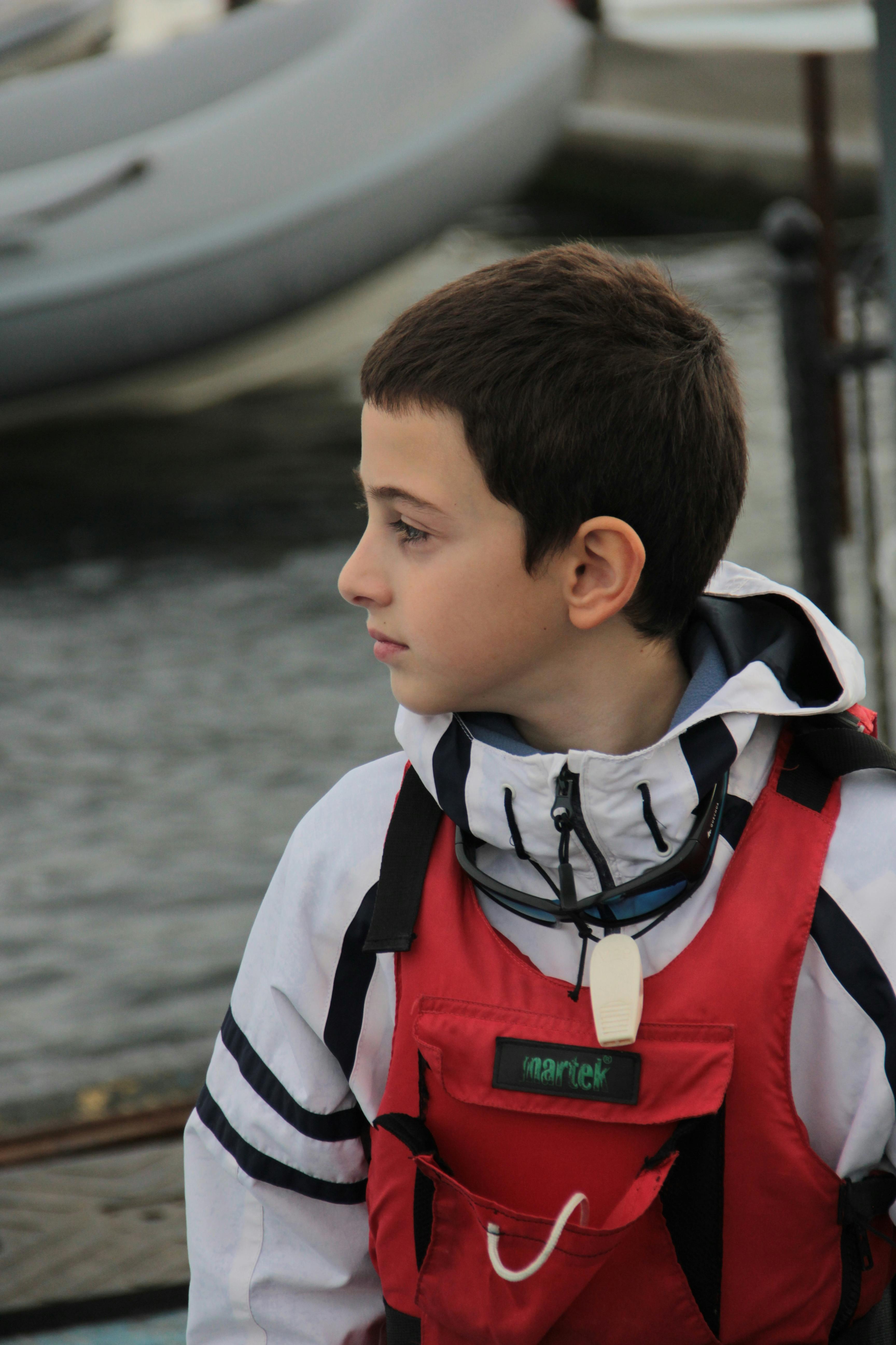 Young Boy in Red Life Vest by Water · Free Stock Photo