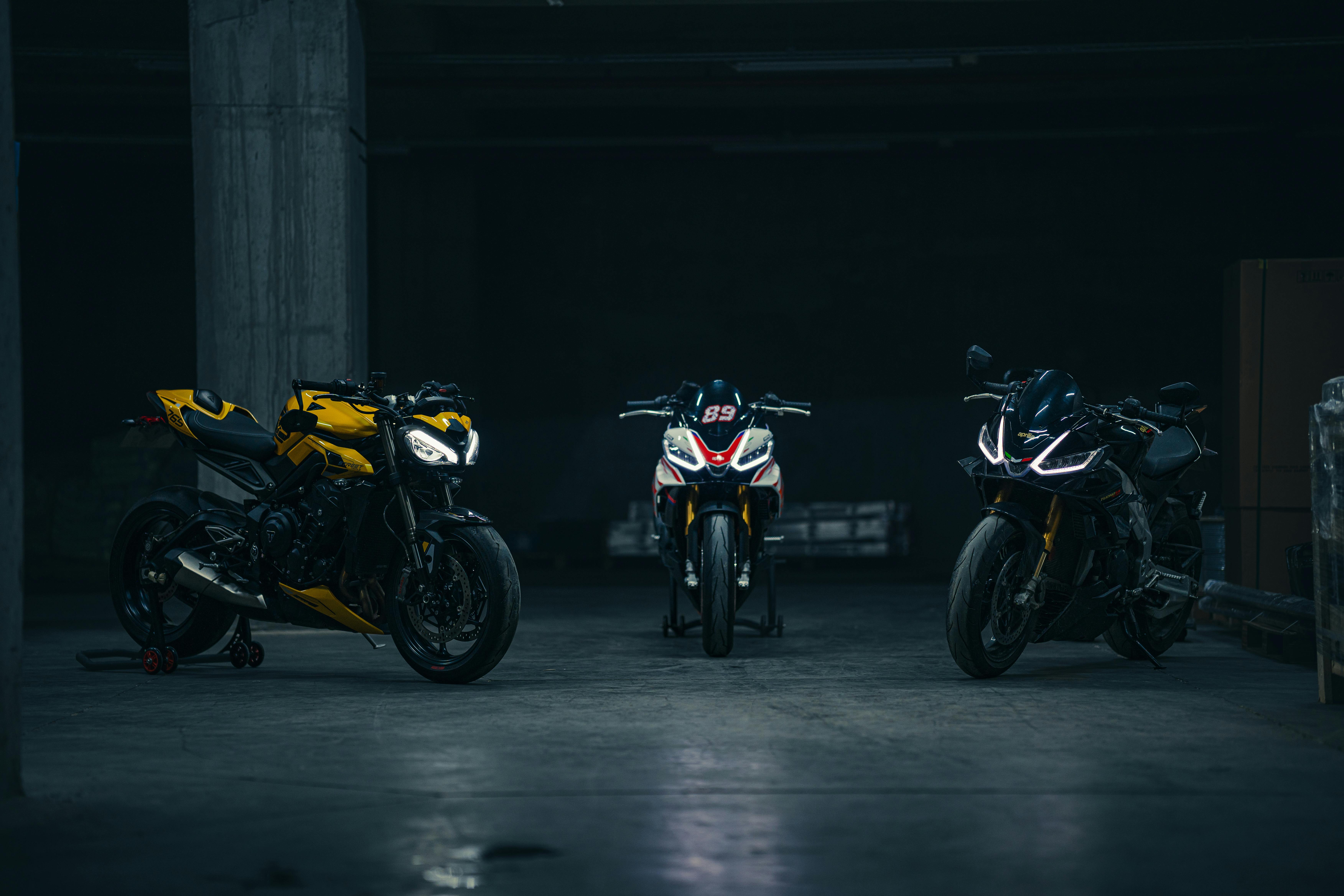 High-Performance Motorcycles in Dimly Lit Garage · Free Stock Photo