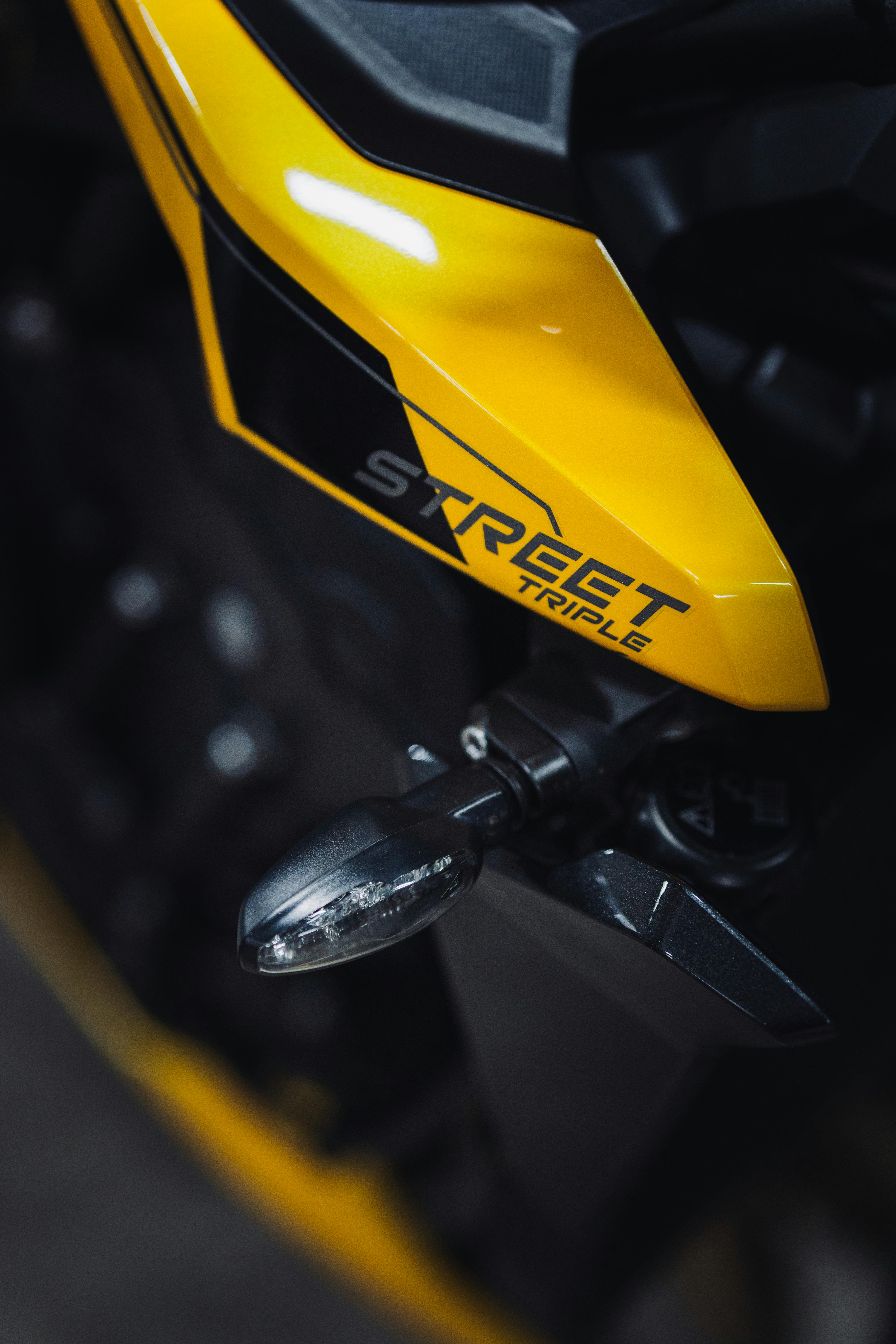 Yellow Motorcycle Close-Up with Street Triple Logo · Free Stock Photo