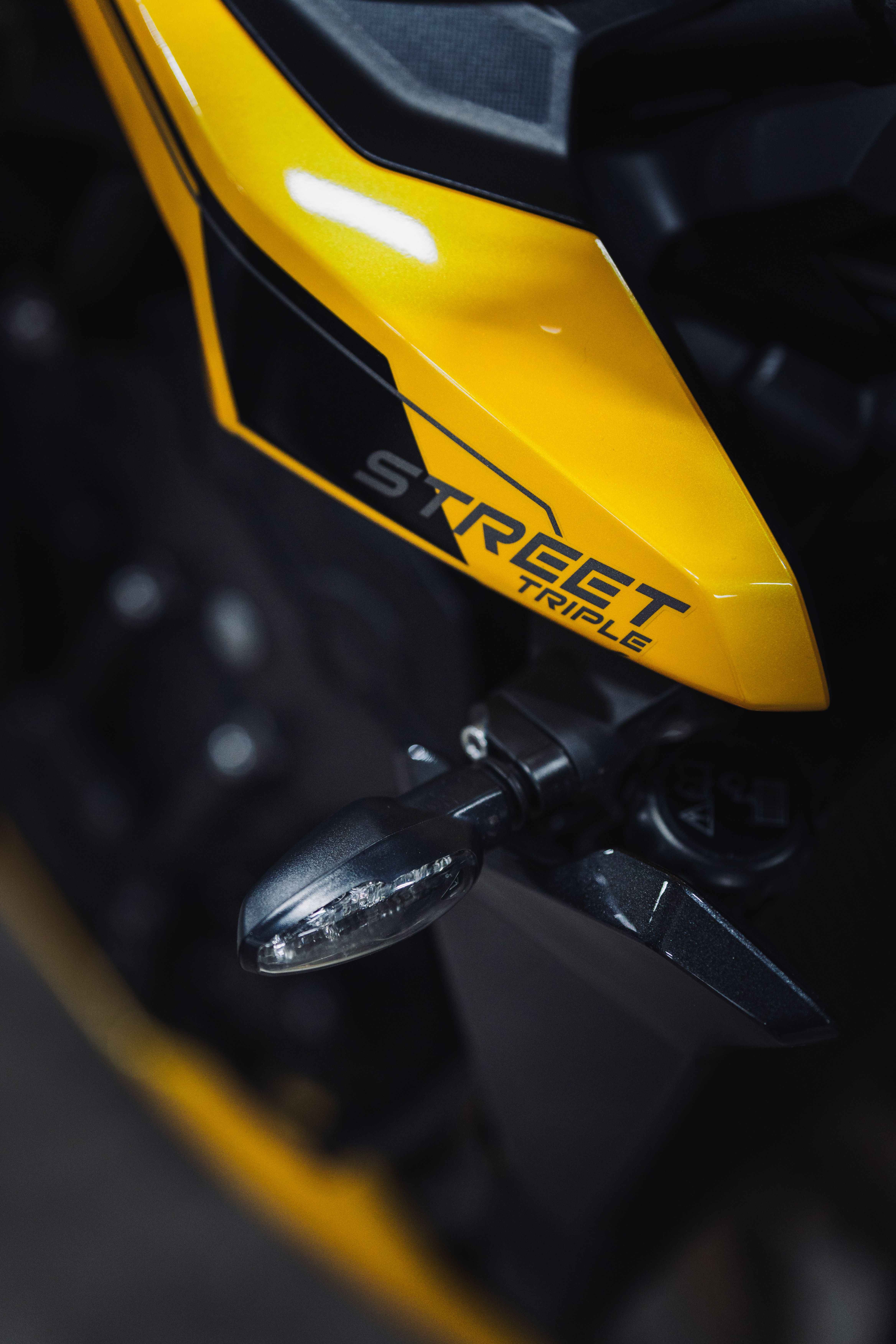 Yellow Motorcycle Close-Up with Street Triple Logo · Free Stock Photo