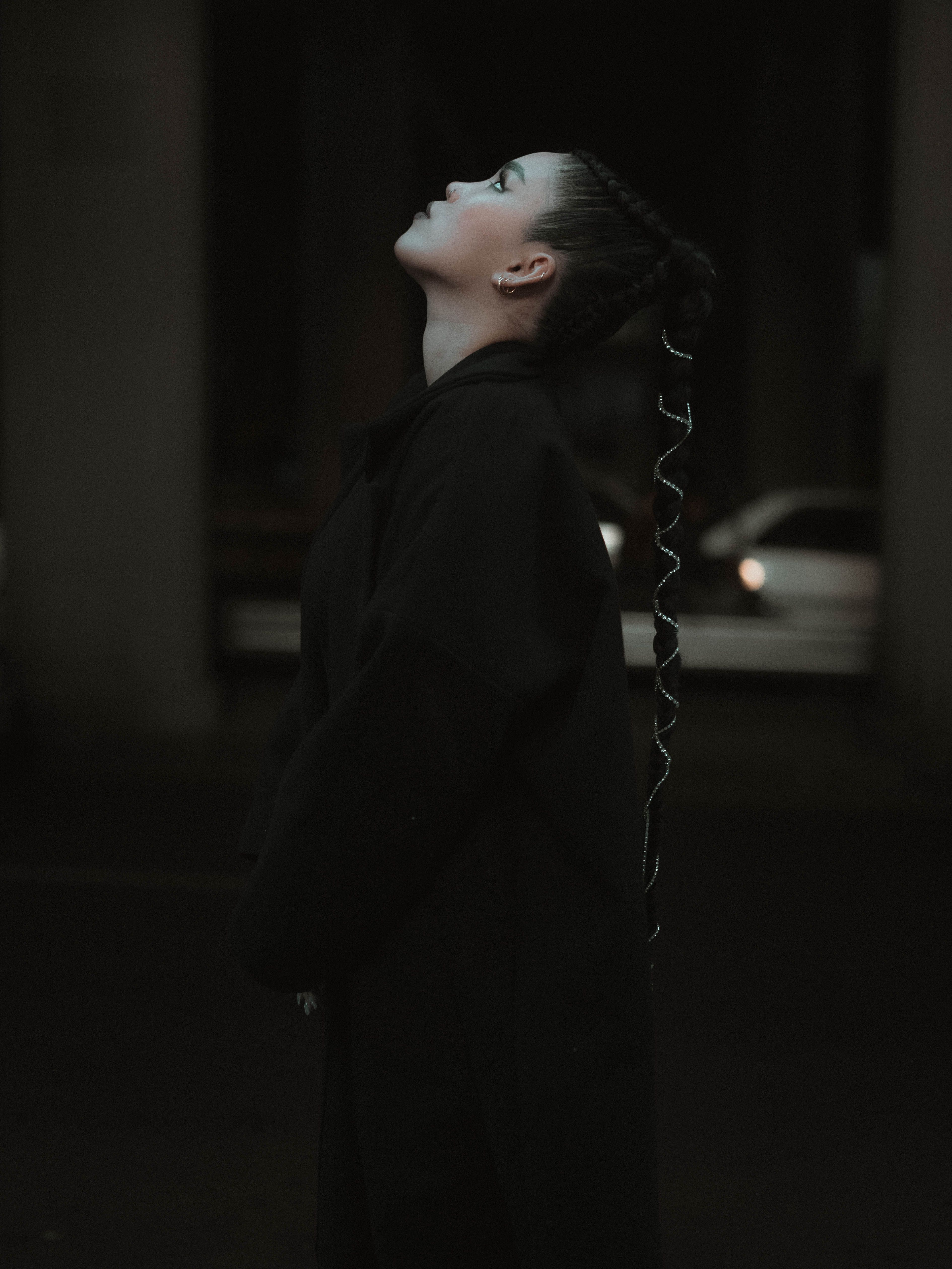 Moody Portrait of Woman in Dark Urban Setting · Free Stock Photo