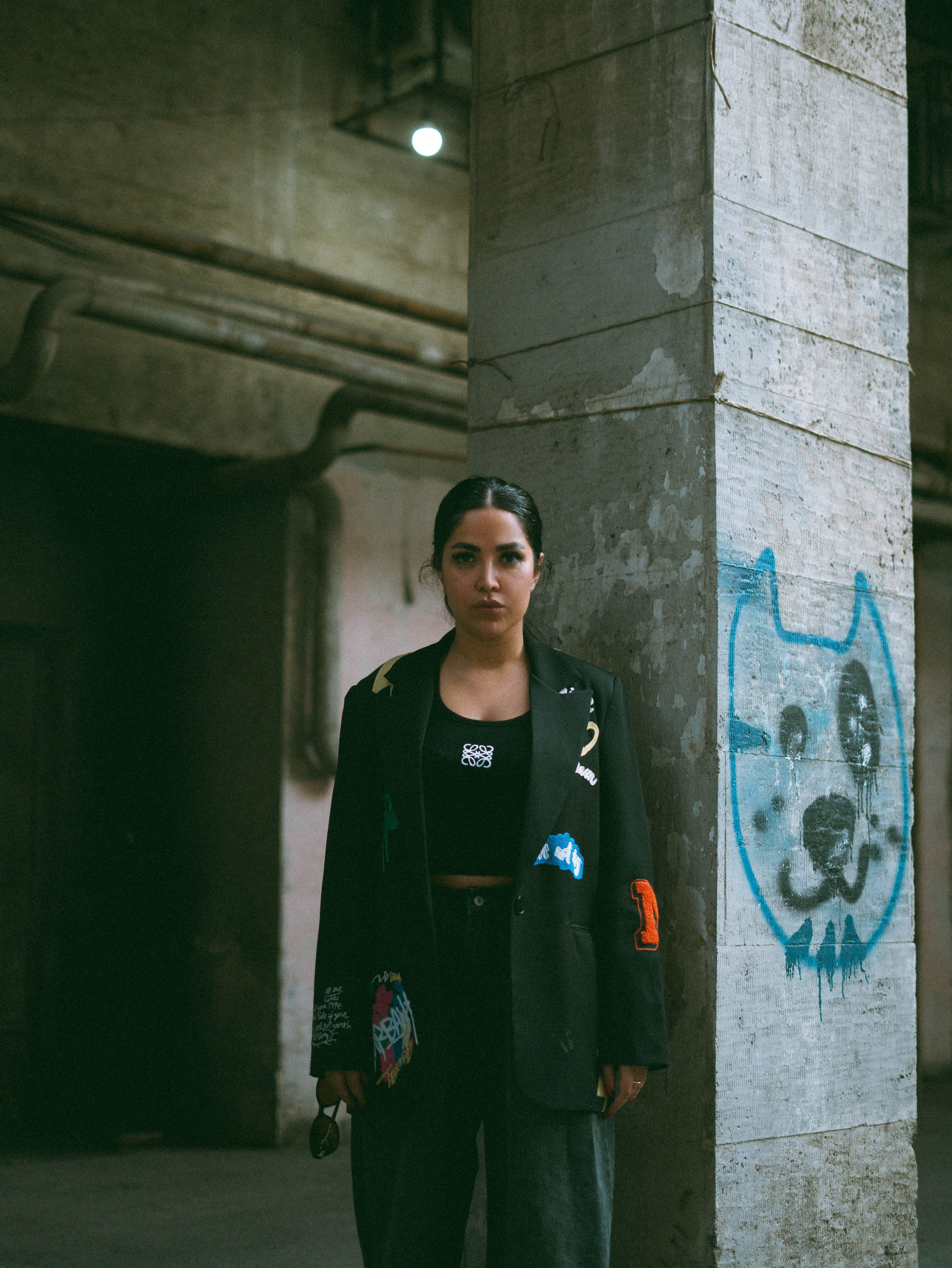 Urban Portrait with Graffiti Art in Subdued Lighting · Free Stock Photo