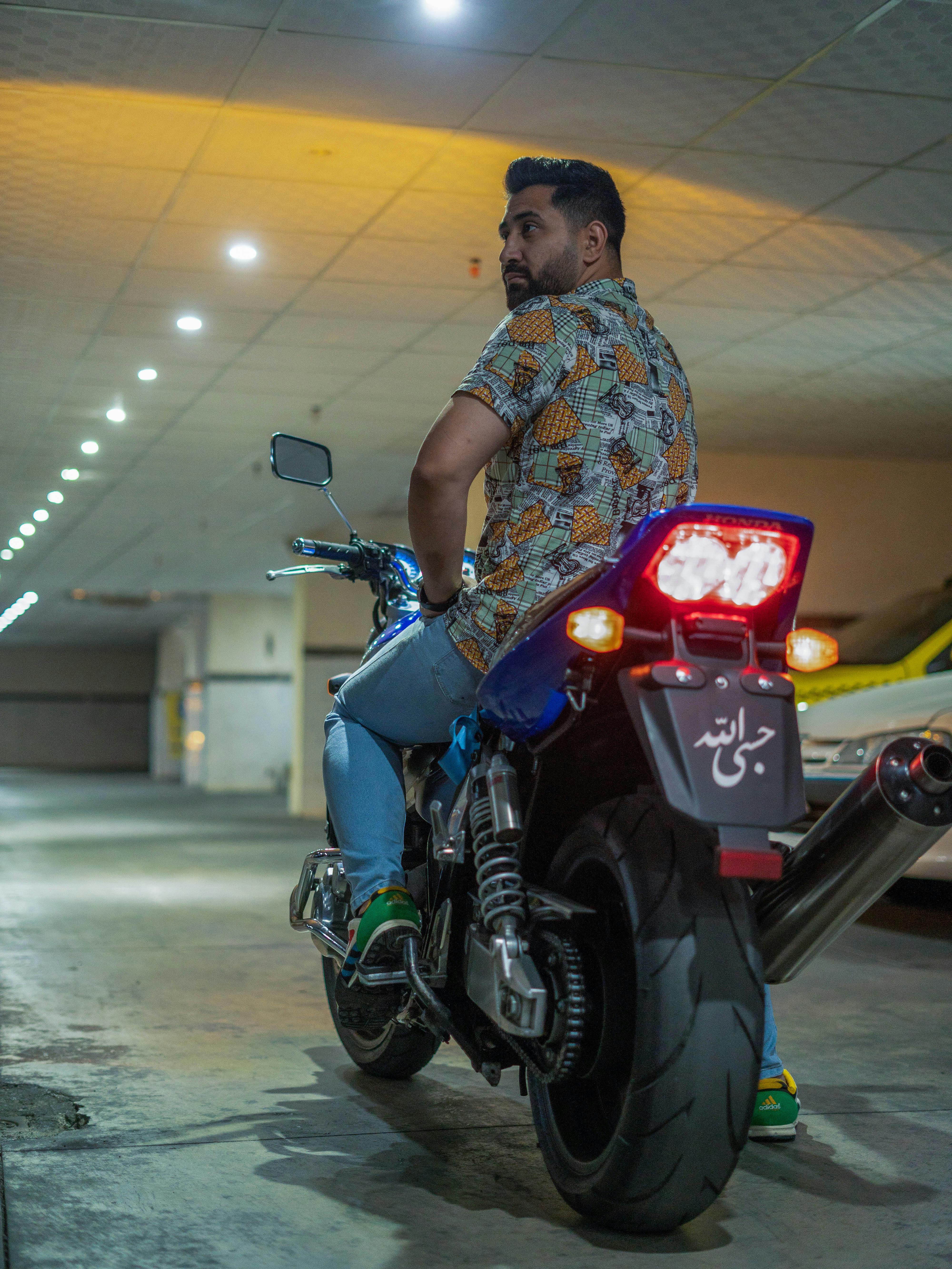 Man on Motorcycle in Underground Garage · Free Stock Photo