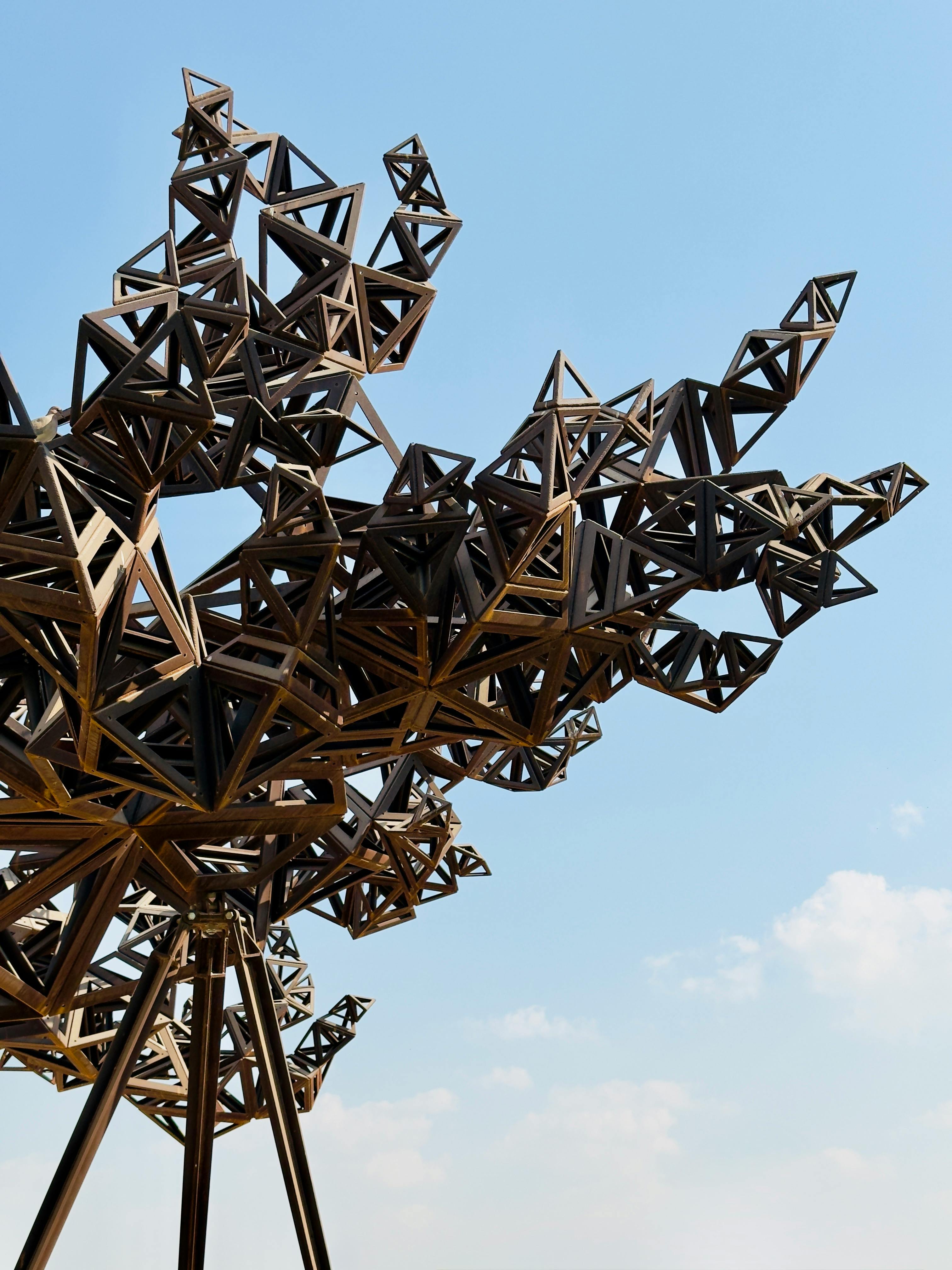 Geometric Metal Sculpture Against Blue Sky · Free Stock Photo