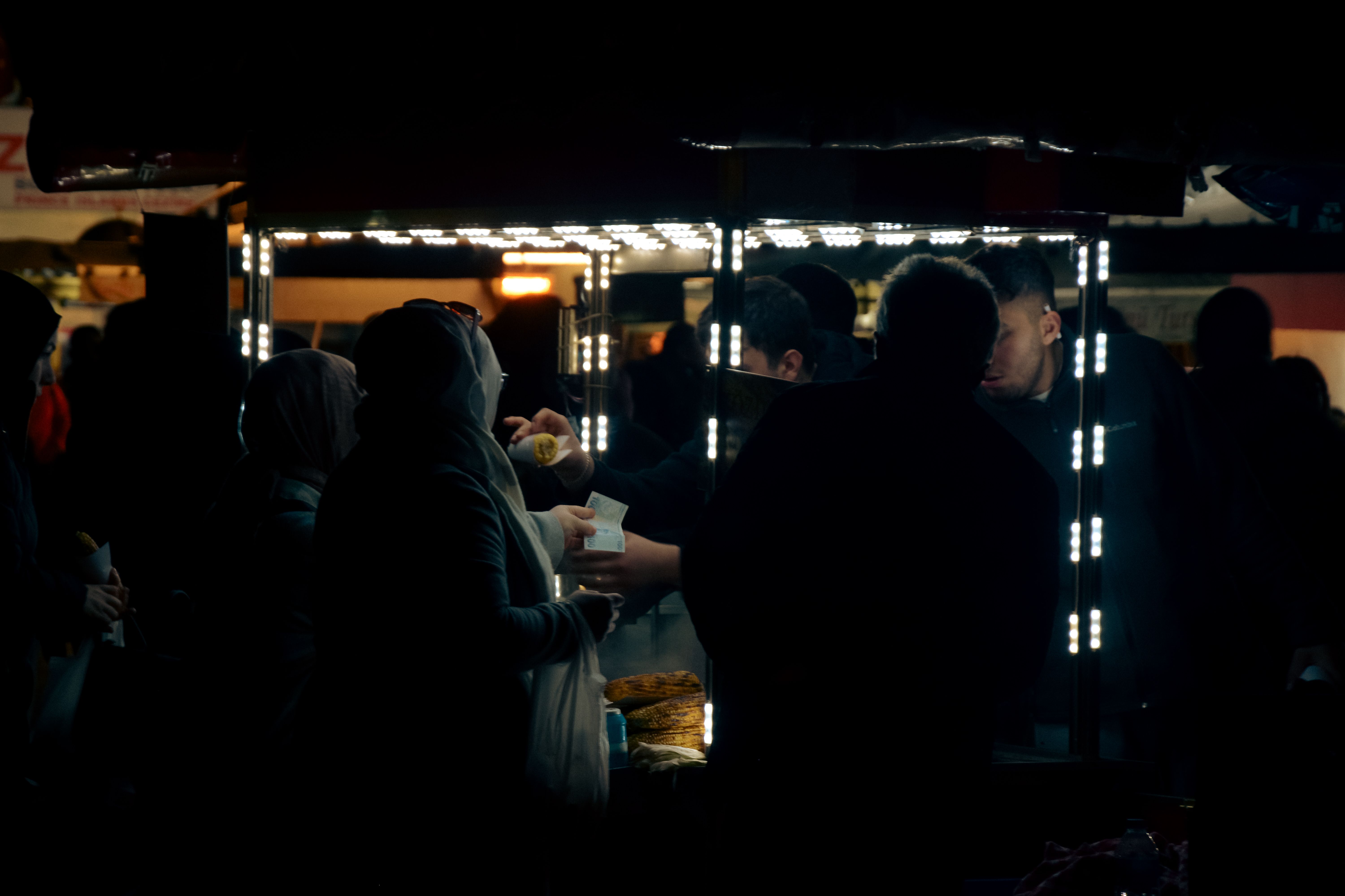 Street Food Stall next to Restaurant at Night · Free Stock Photo