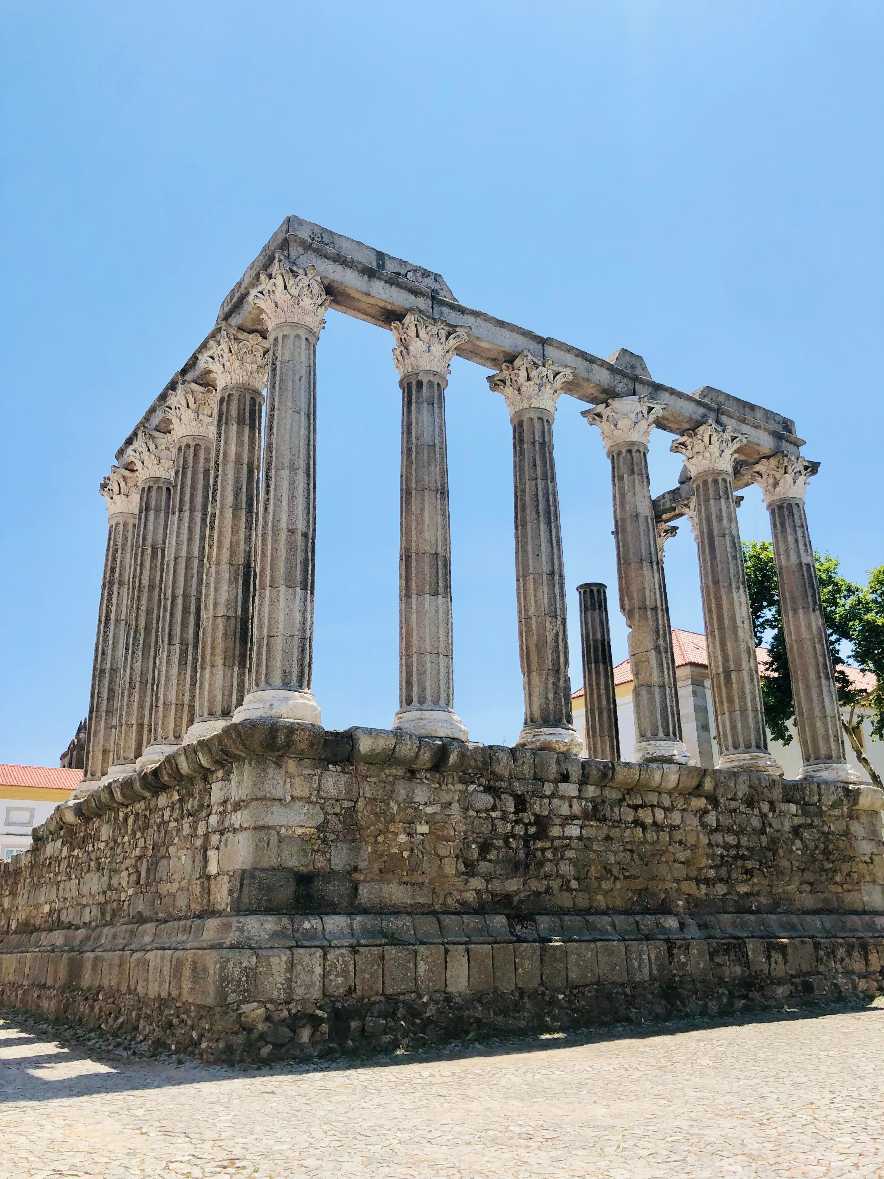 Ancient Roman Temple Ruins Under Clear Blue Sky · Free Stock Photo