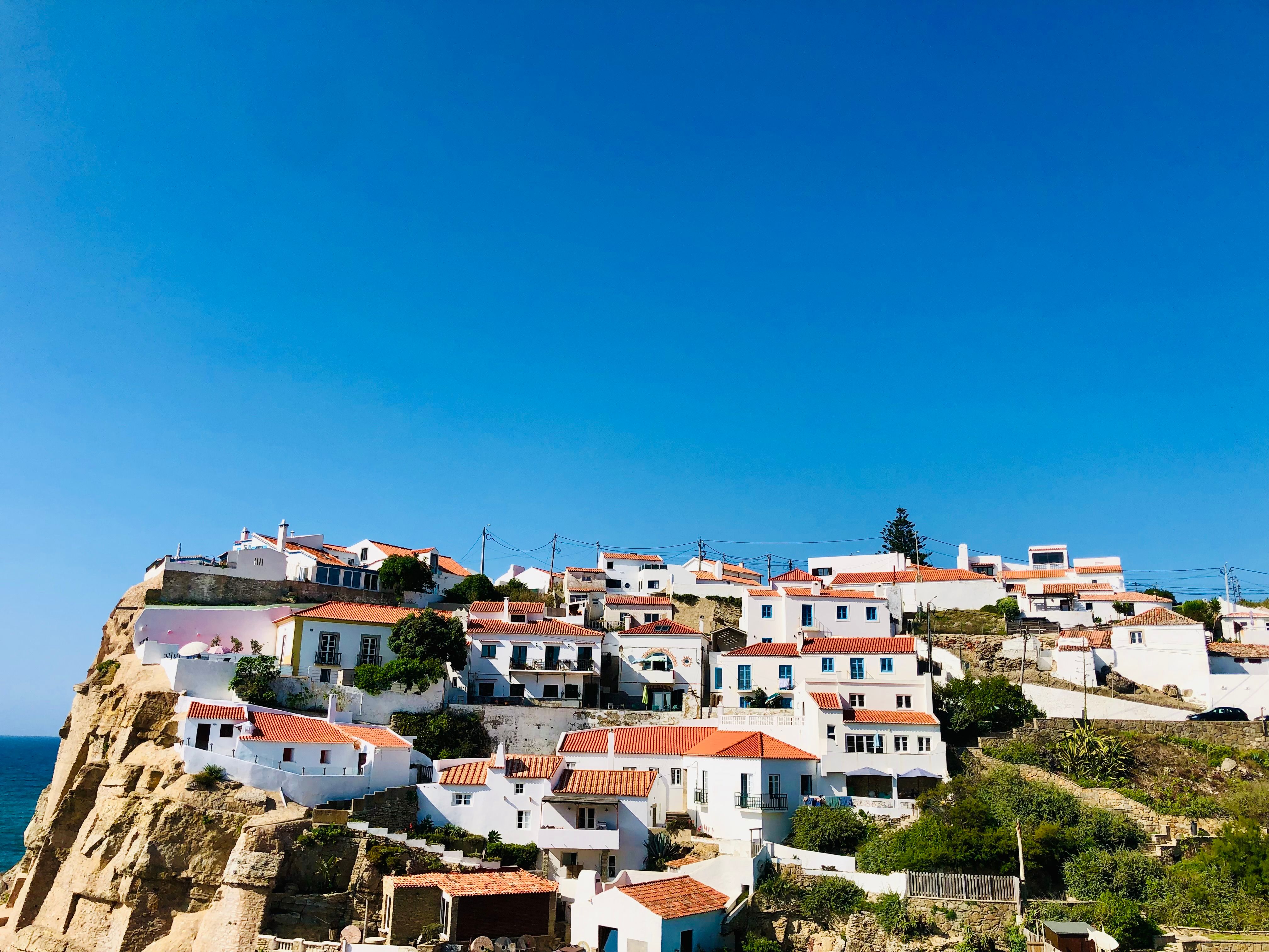 Charming Coastal Village with White Houses on Cliff · Free Stock Photo