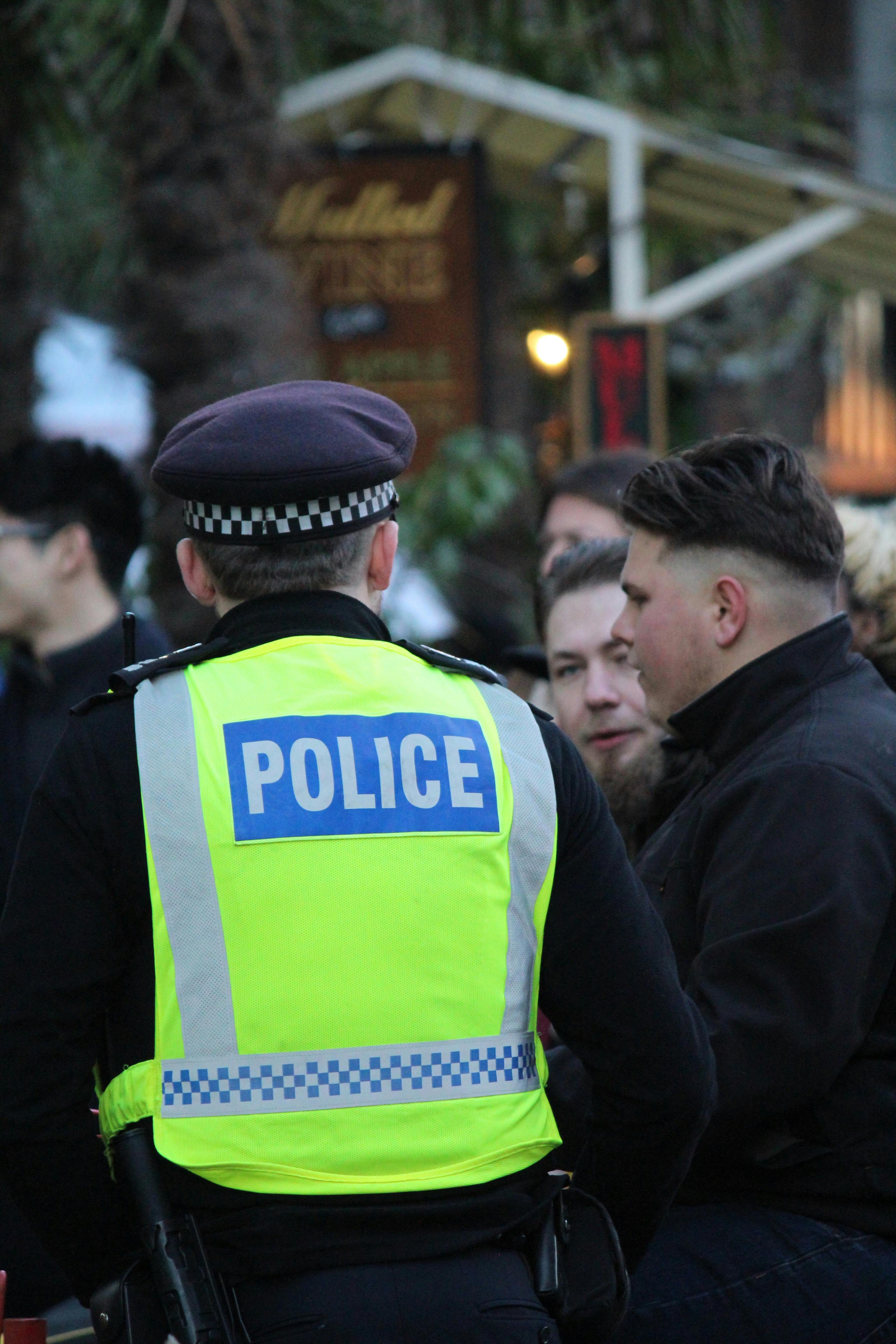Police Officer Interacting with City Crowd · Free Stock Photo