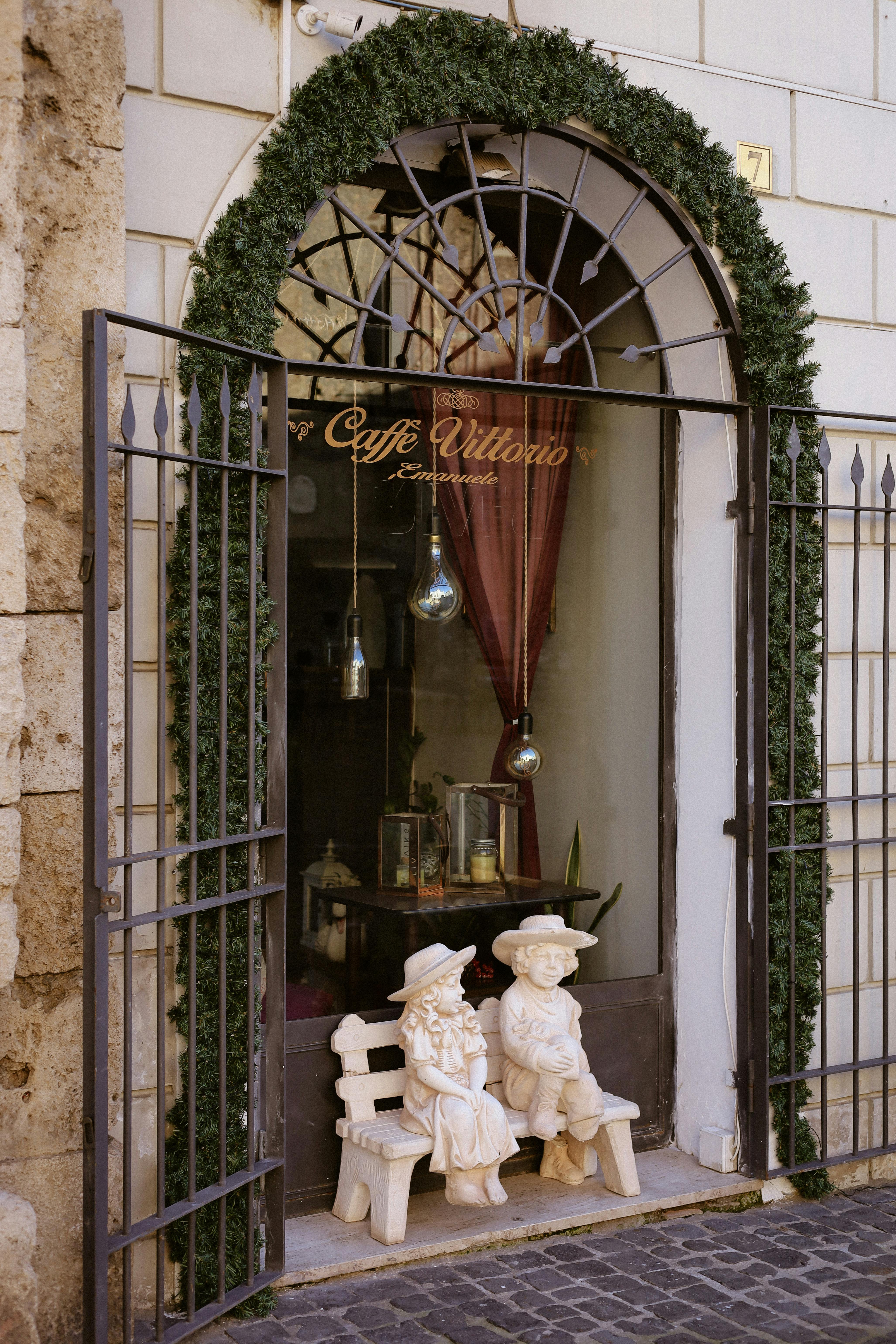 Charming outdoor café entrance with vintage decor · Free Stock Photo