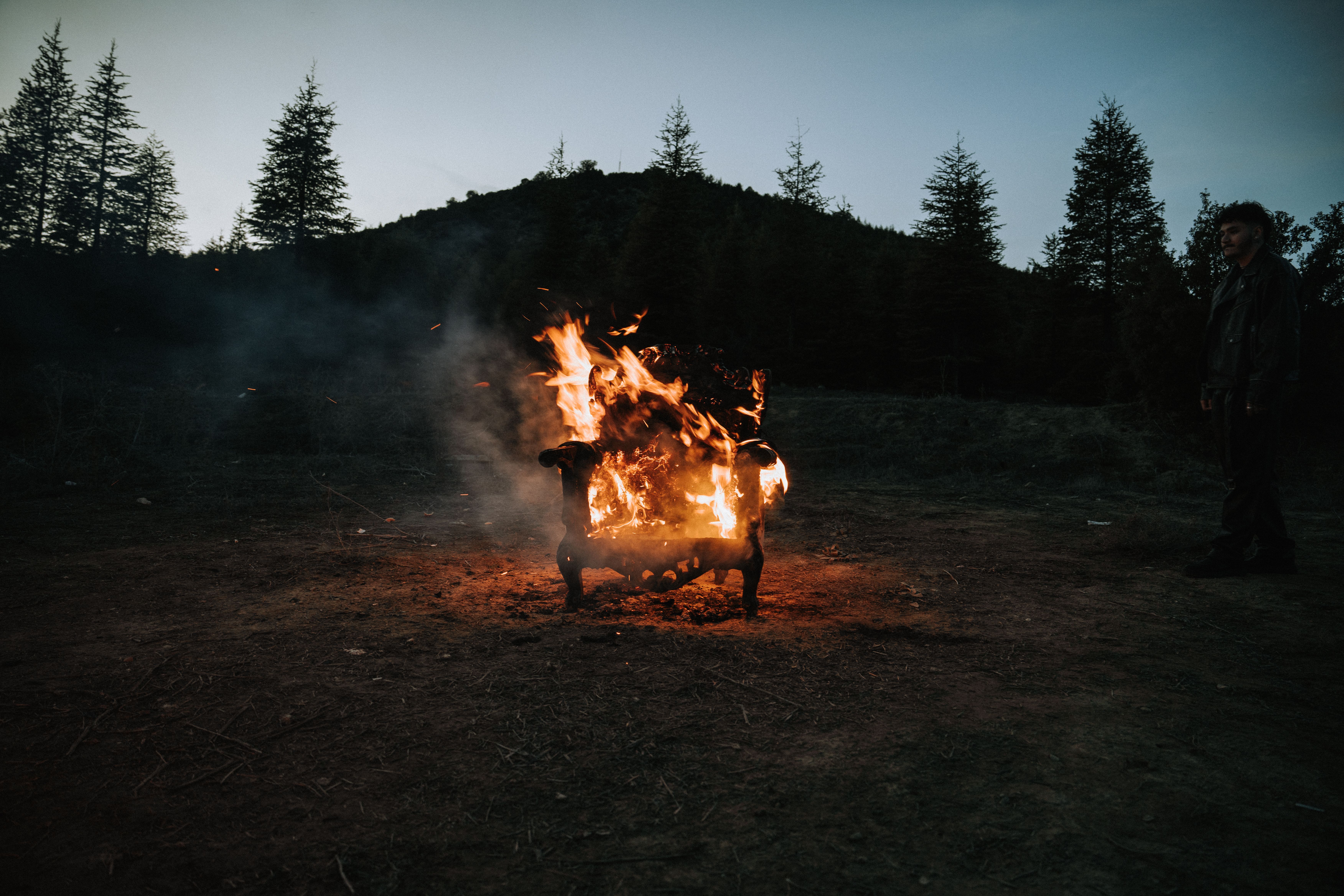 Fiery Scene with Burning Chair Outdoors at Dusk · Free Stock Photo