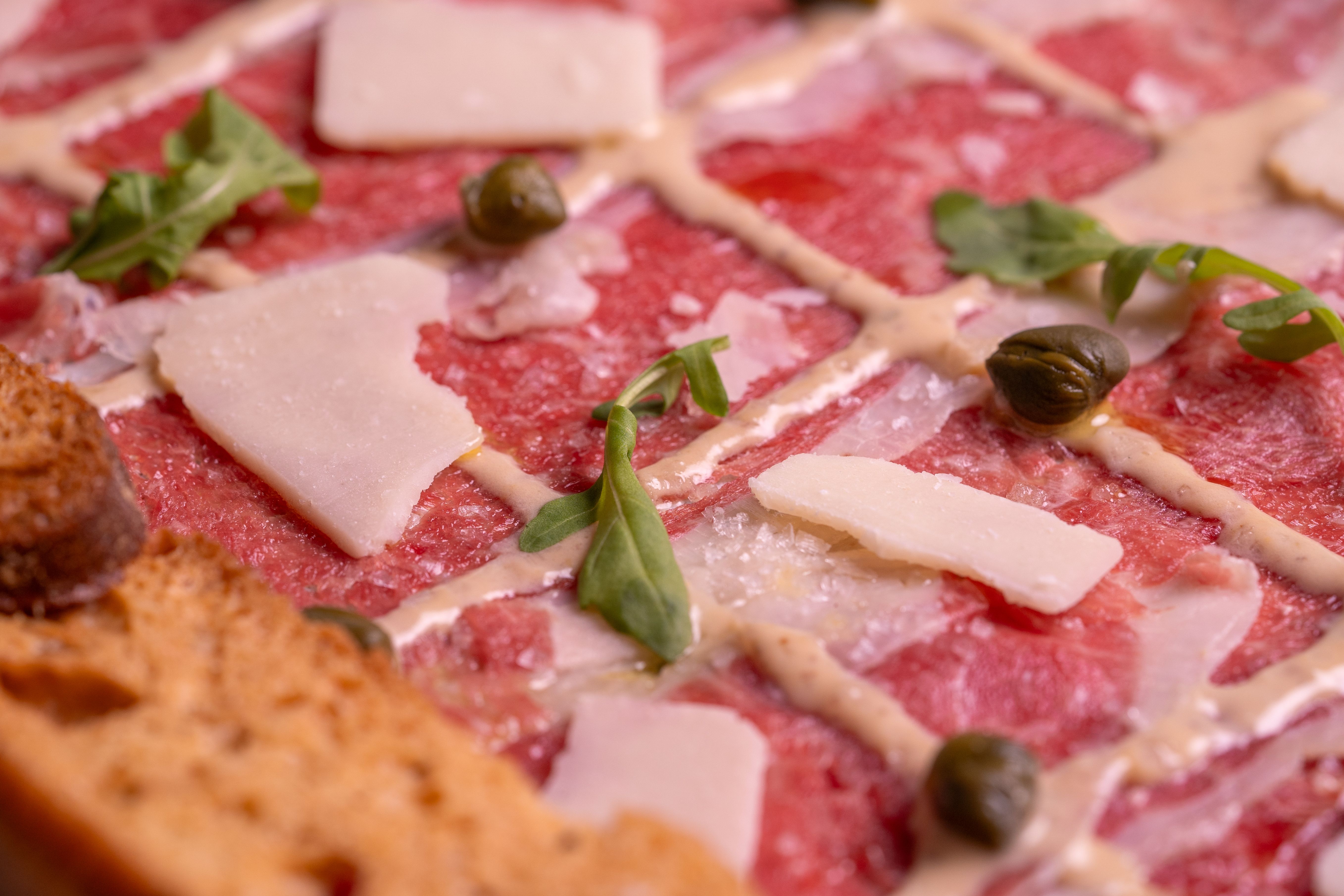 Delicious Beef Carpaccio with Parmesan and Capers · Free Stock Photo