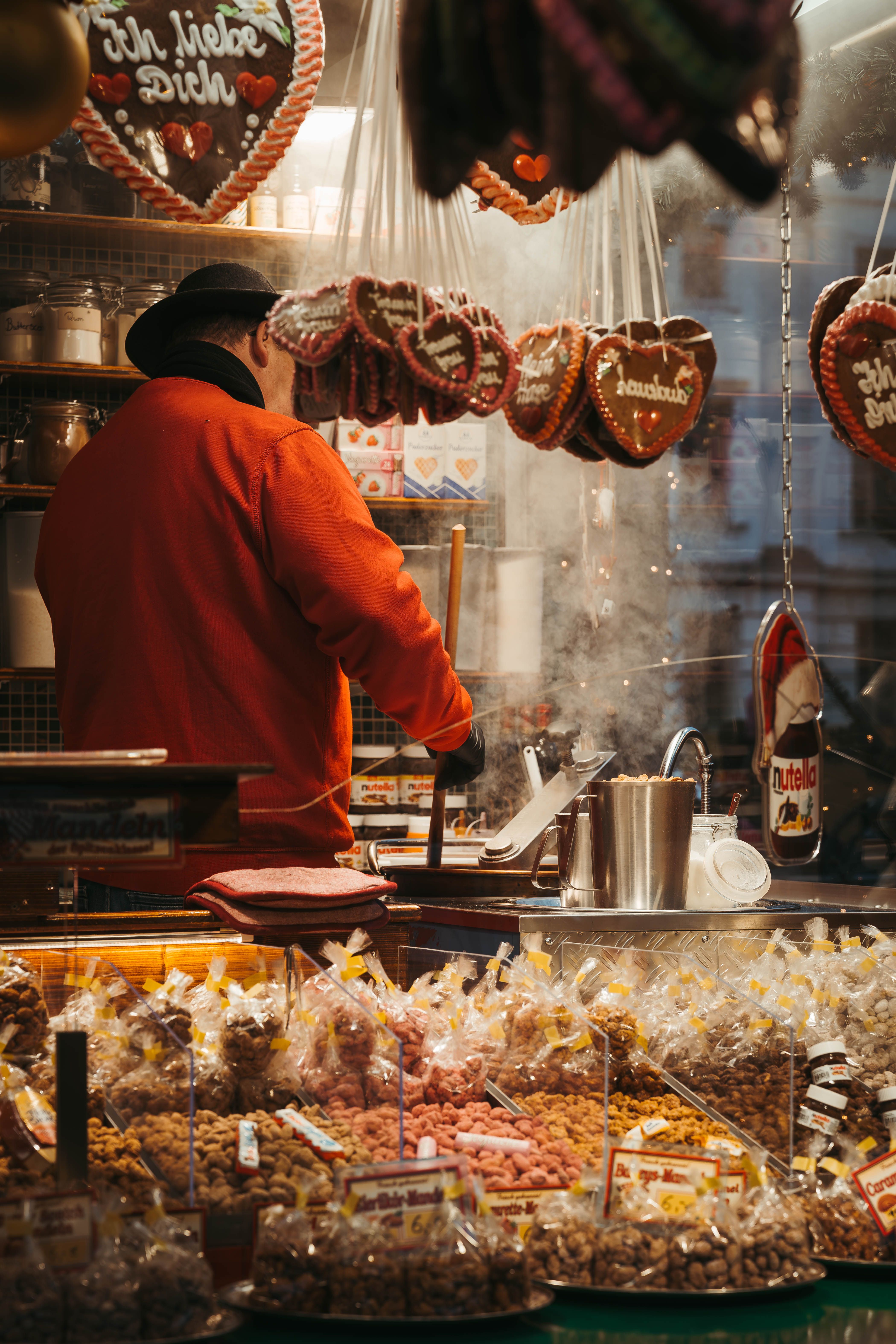 Vendor Preparing Treats at German Market Stall · Free Stock Photo