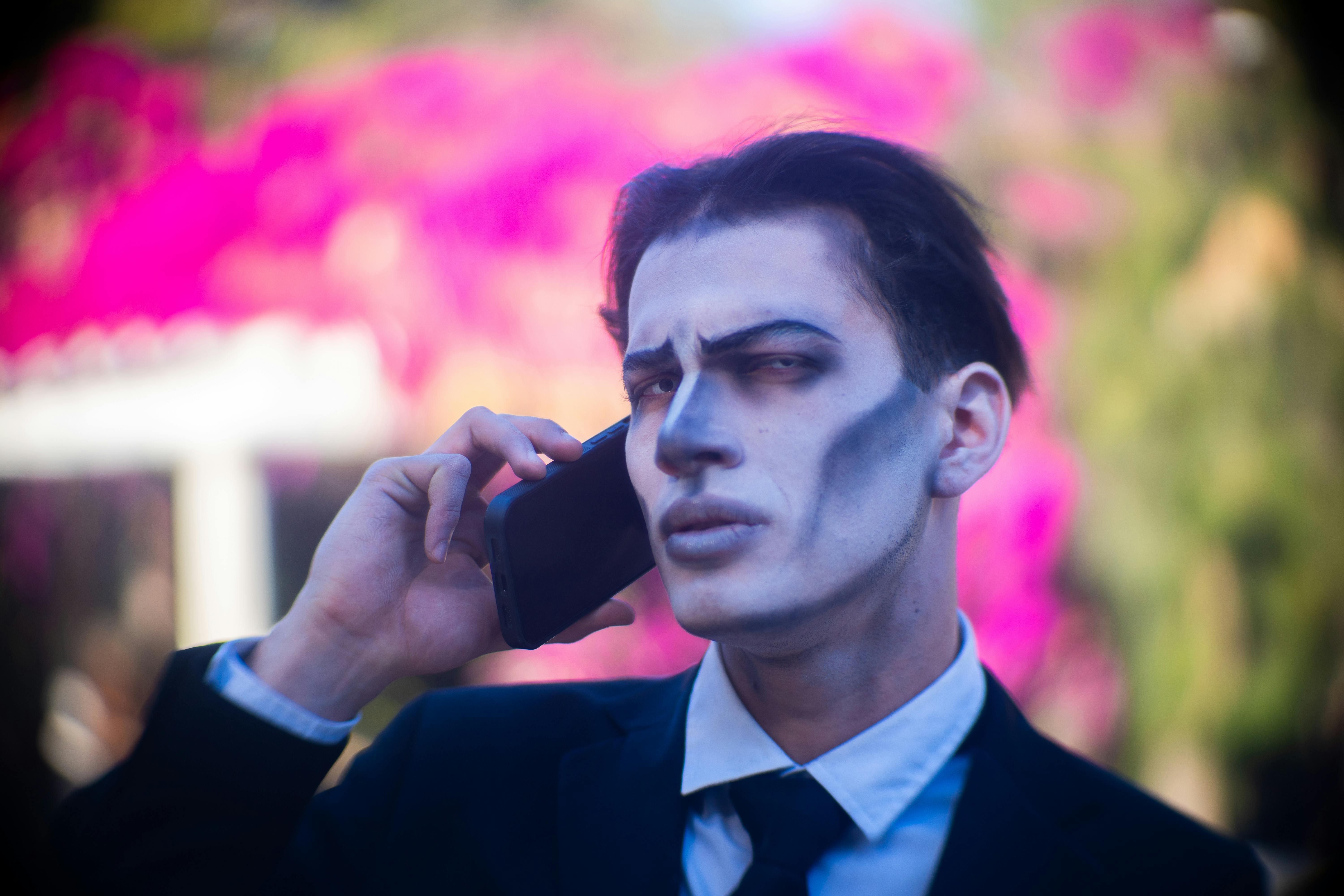 Man with Gothic Makeup Talking on Cell Phone · Free Stock Photo