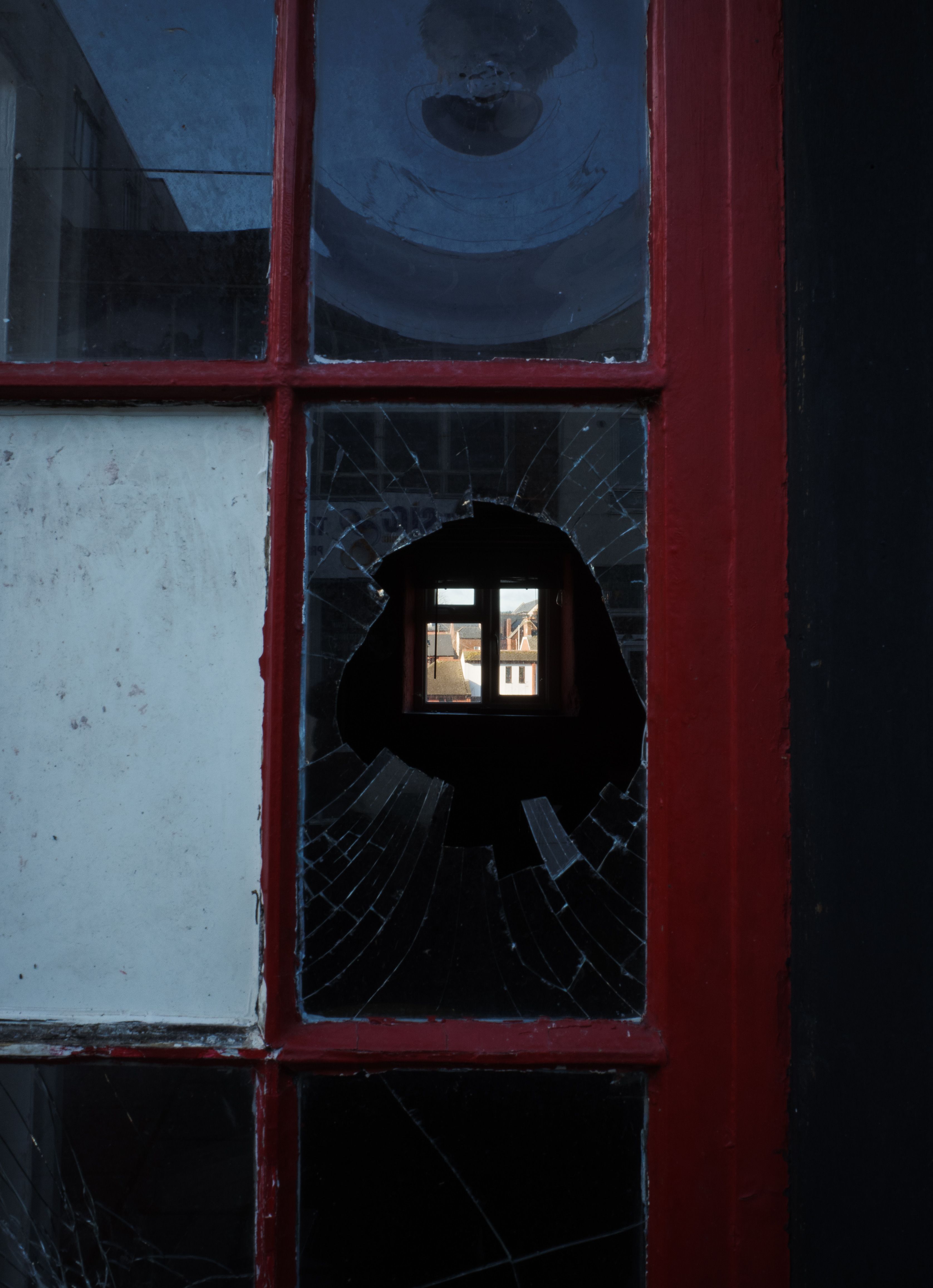 Broken Window with Architectural Reflection · Free Stock Photo