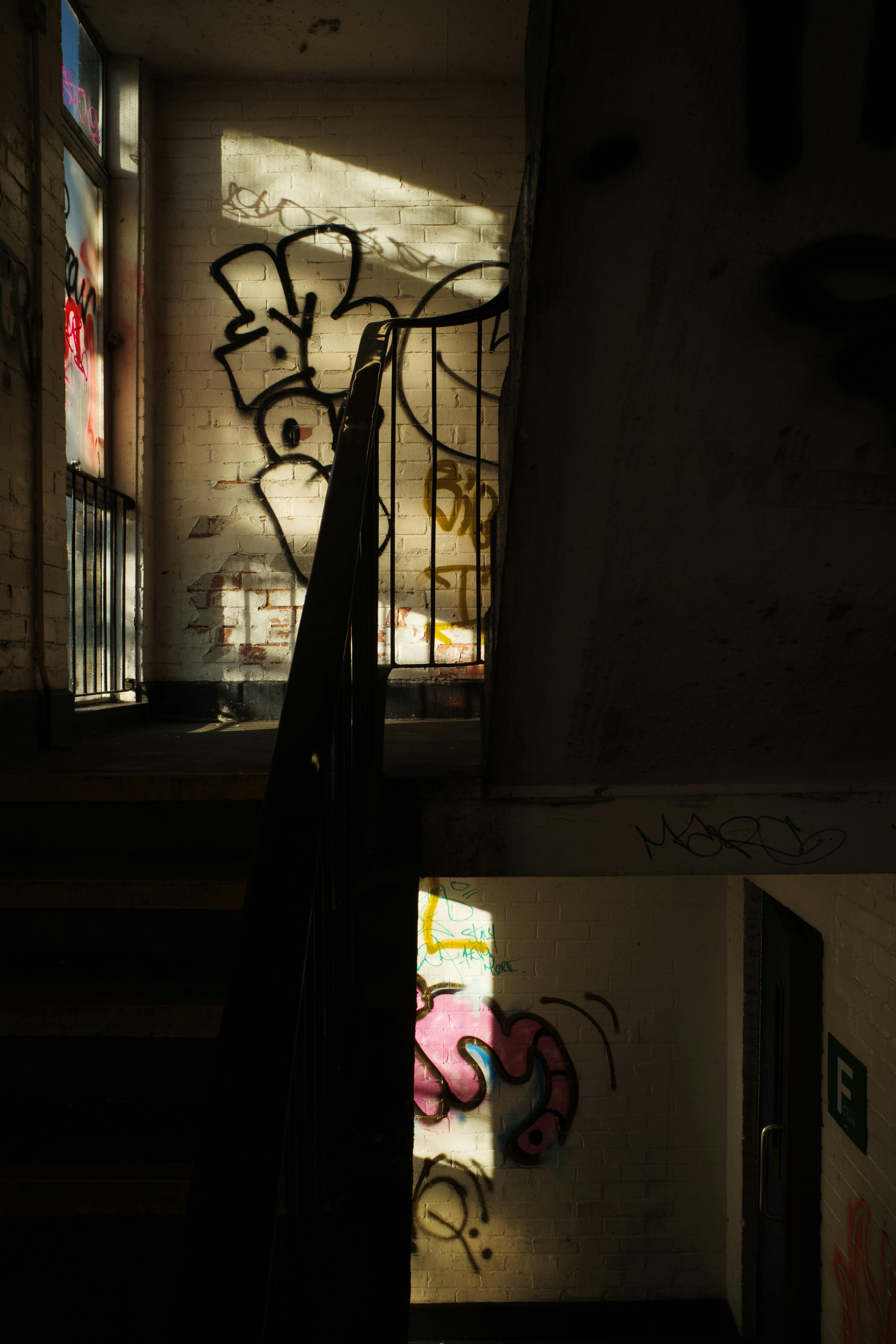 Moody Stairwell with Artistic Graffiti Shadows · Free Stock Photo