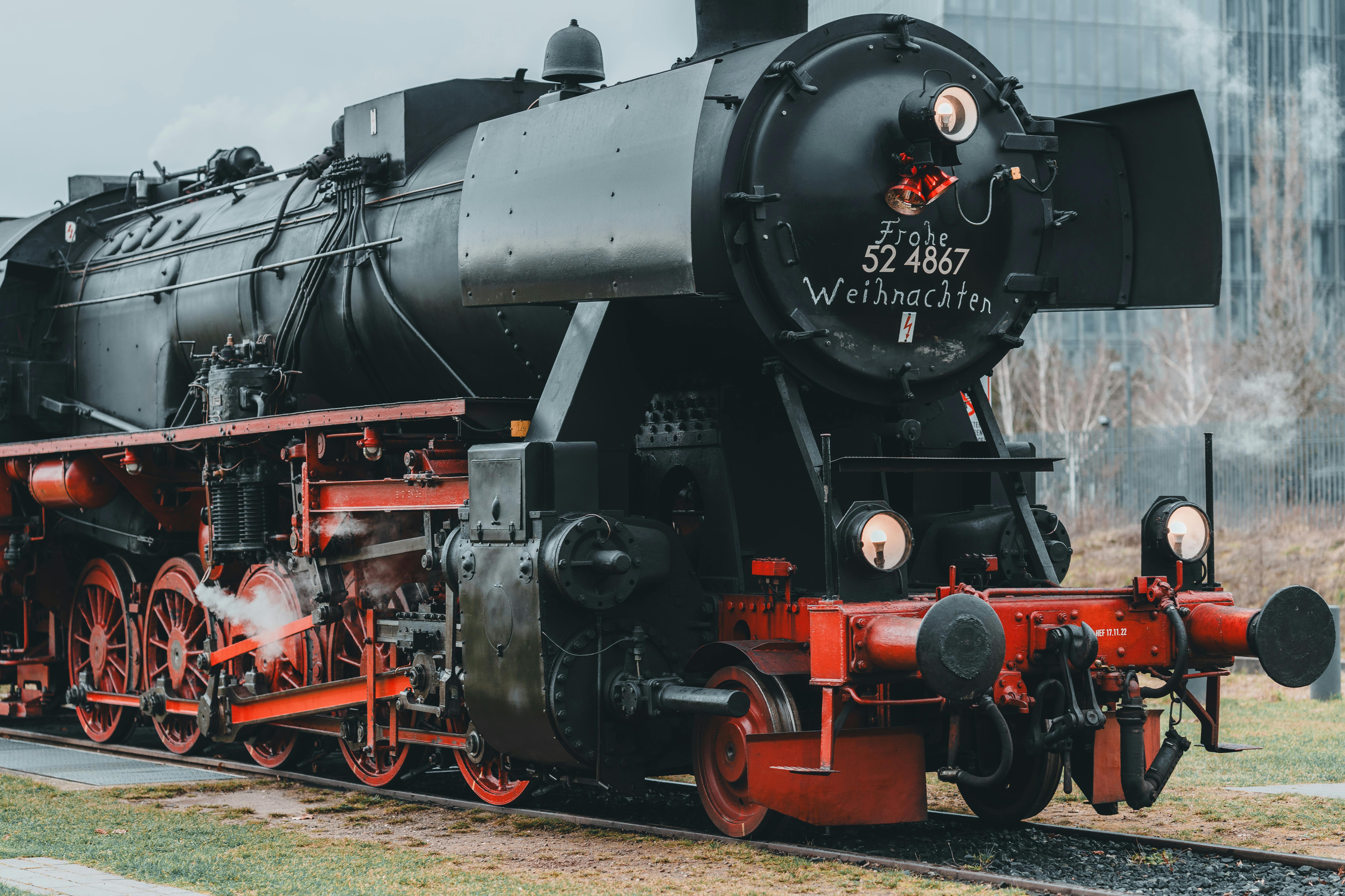 Historic Steam Locomotive on Rails Outdoors · Free Stock Photo