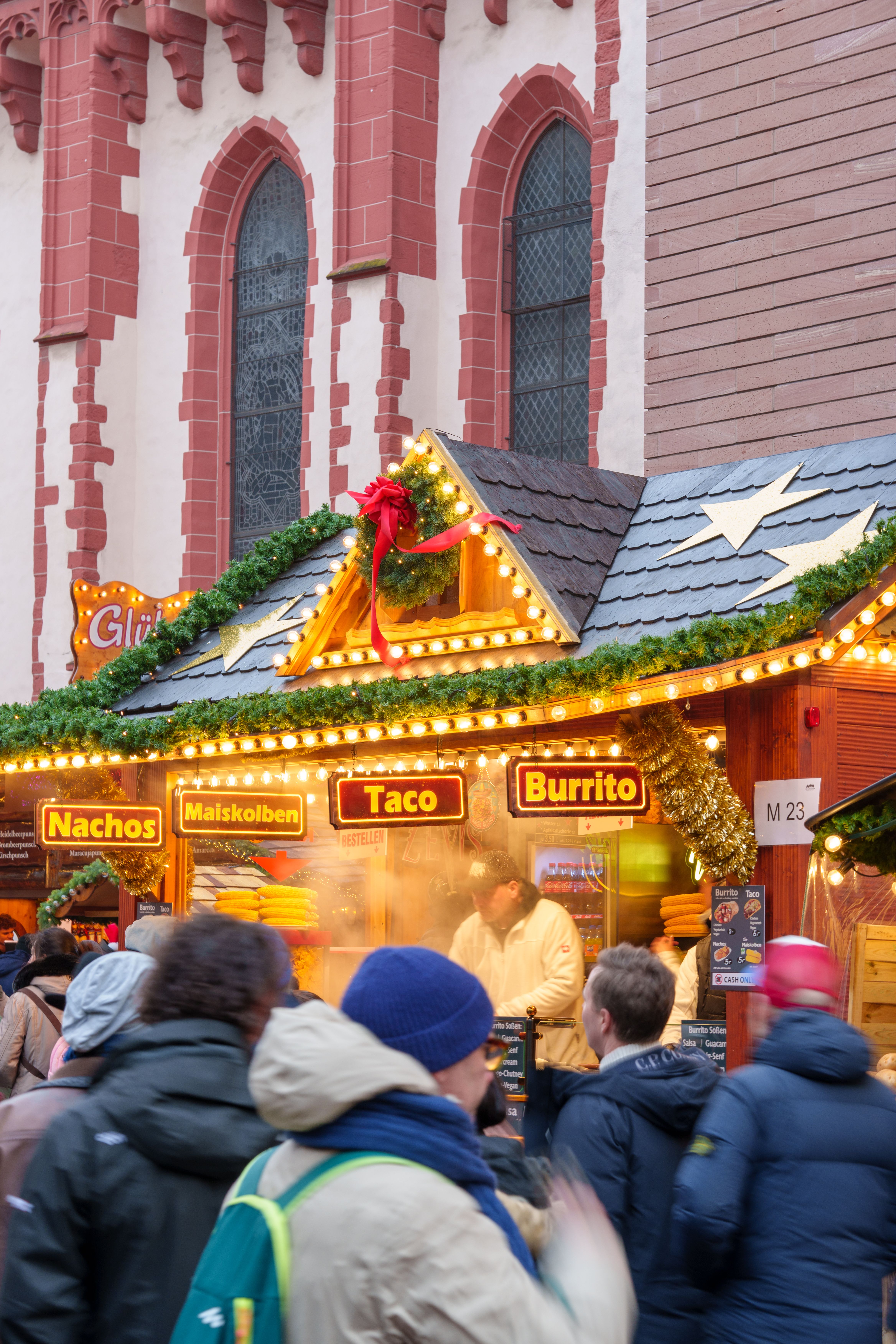 Festive Market Stall with Food and Crowd in Winter · Free Stock Photo