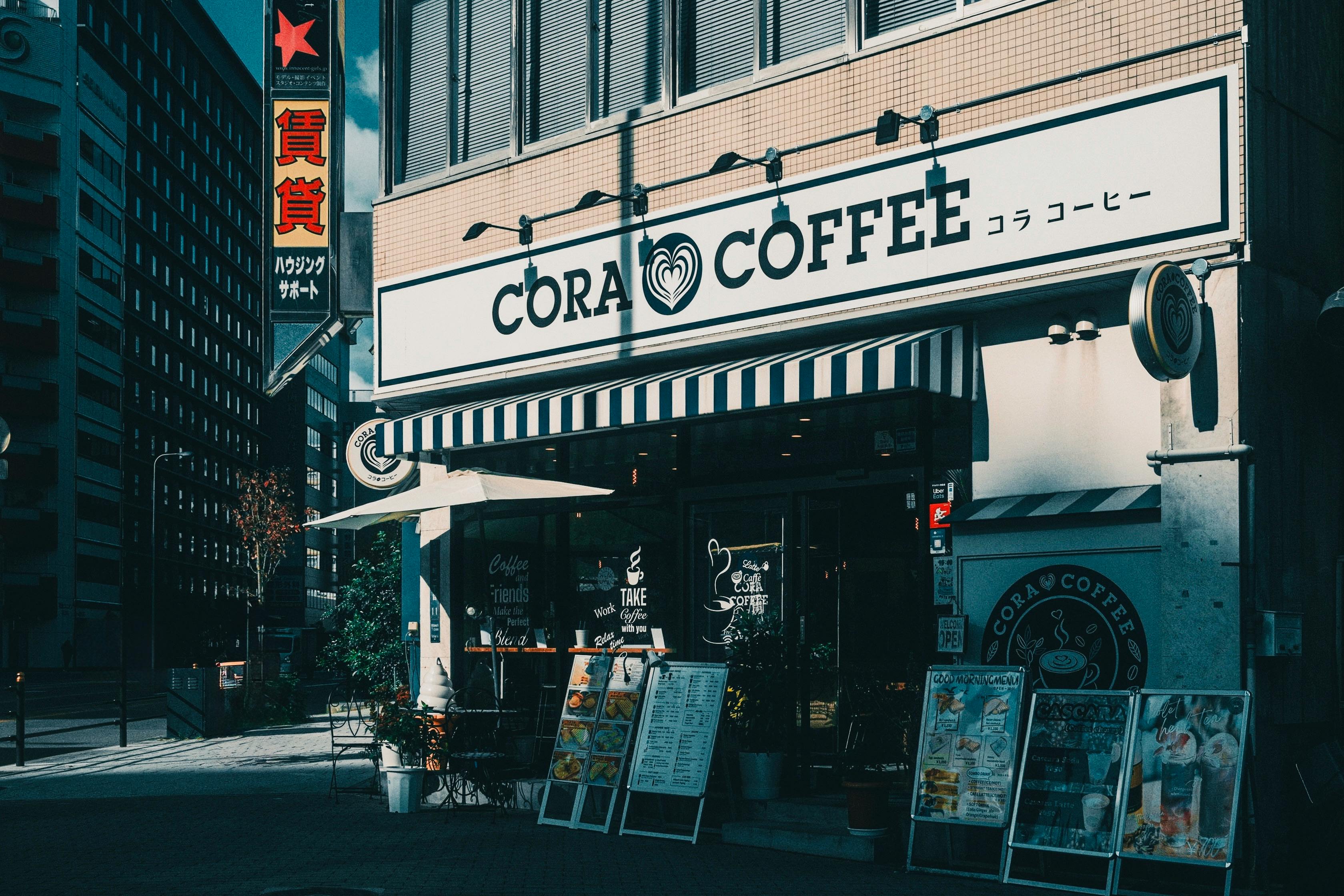 Charming Urban Coffee Shop Exterior on City Street · Free Stock Photo