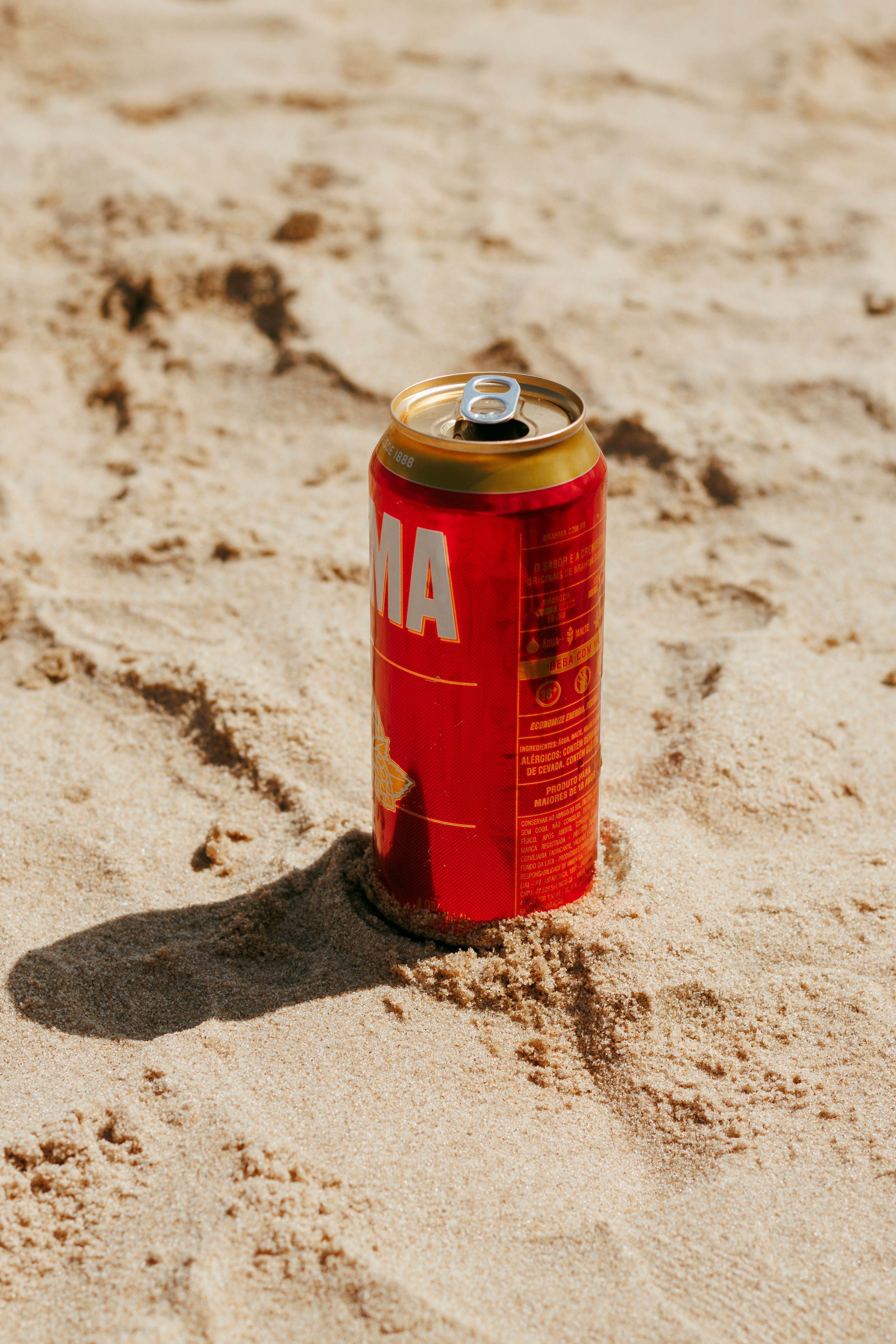 Red Soda Can in Sandy Outdoor Setting · Free Stock Photo