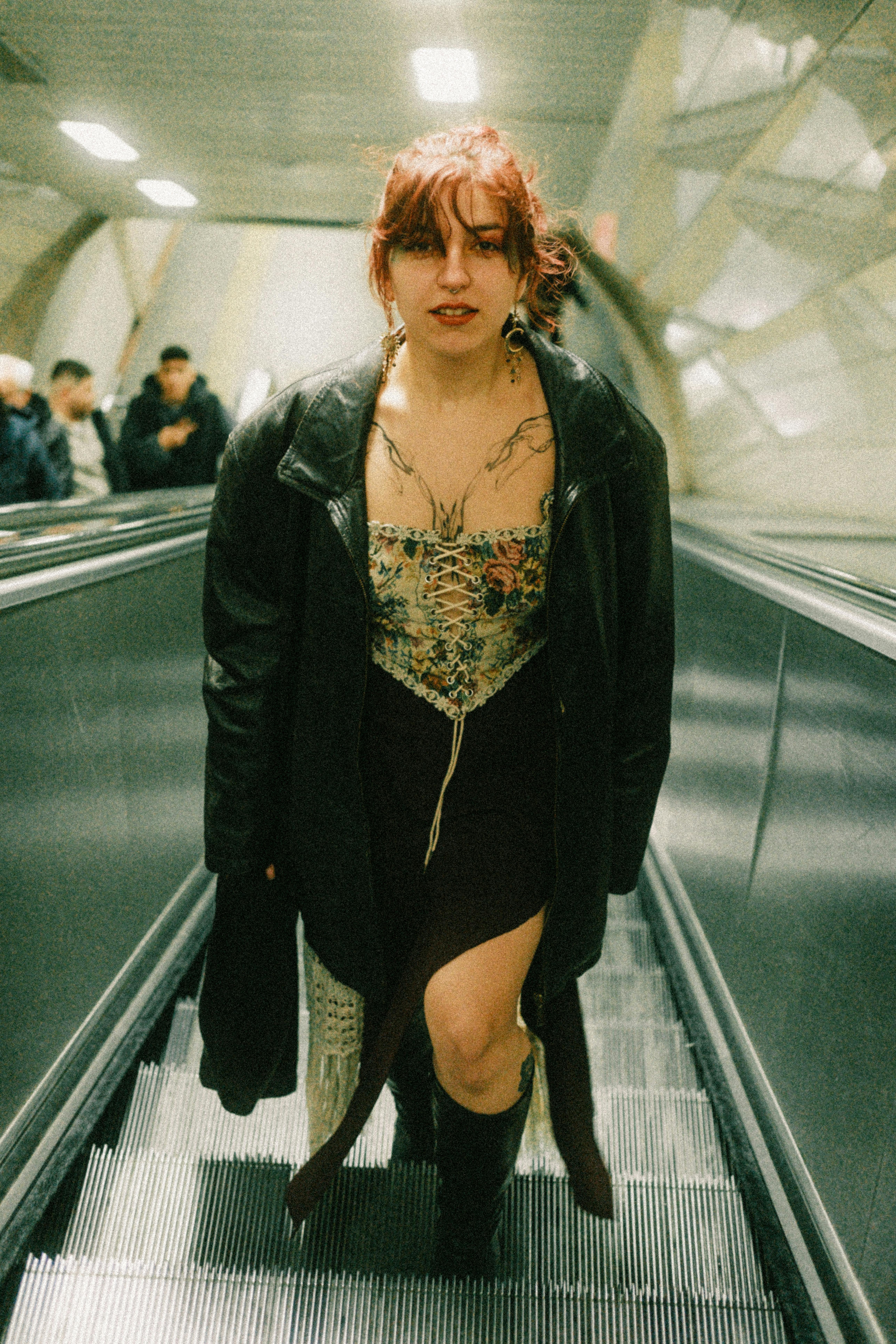 Young Woman on Subway Escalator Wearing Urban Outfit · Free Stock Photo