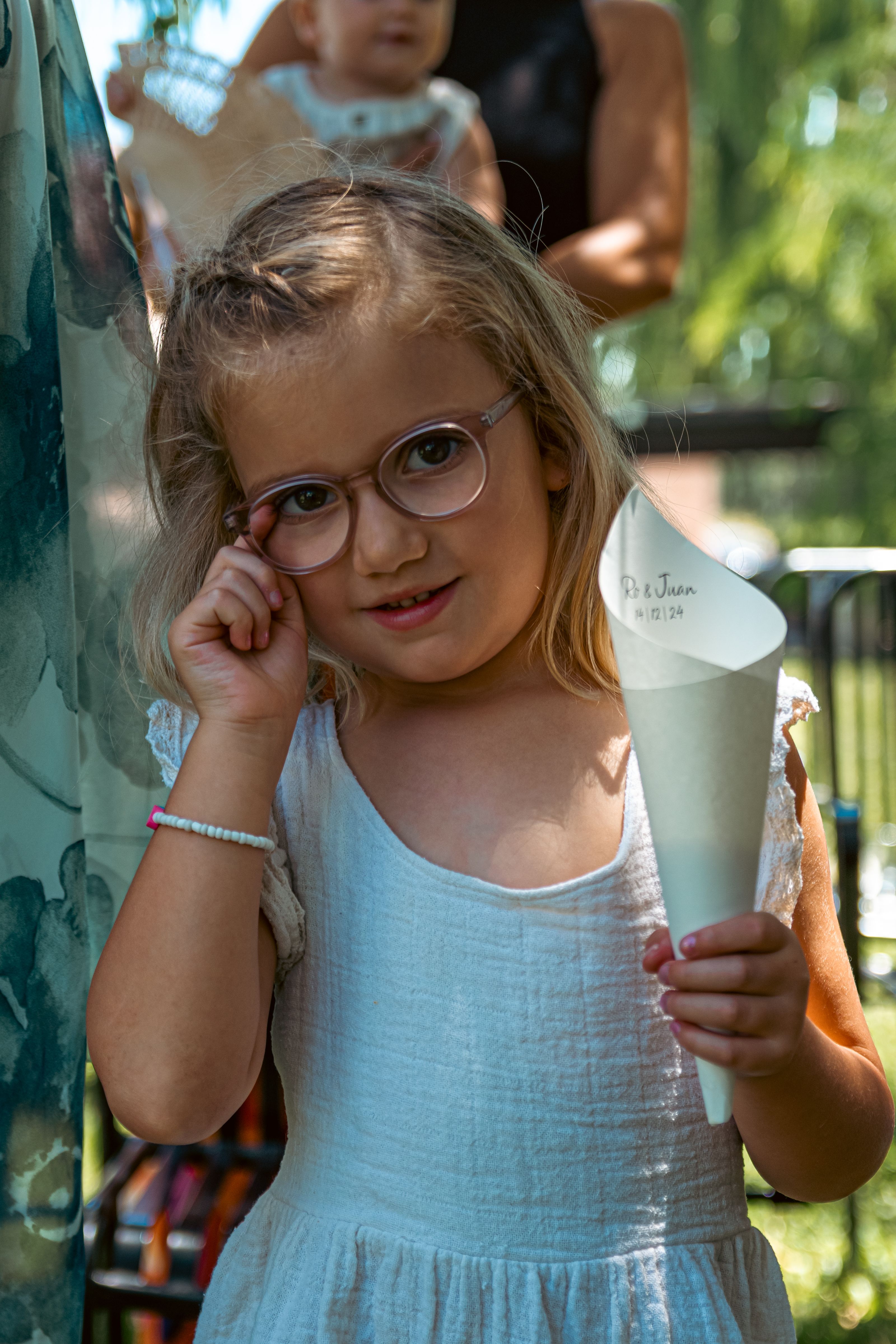 Charming Child Holding Cone at Outdoor Event · Free Stock Photo