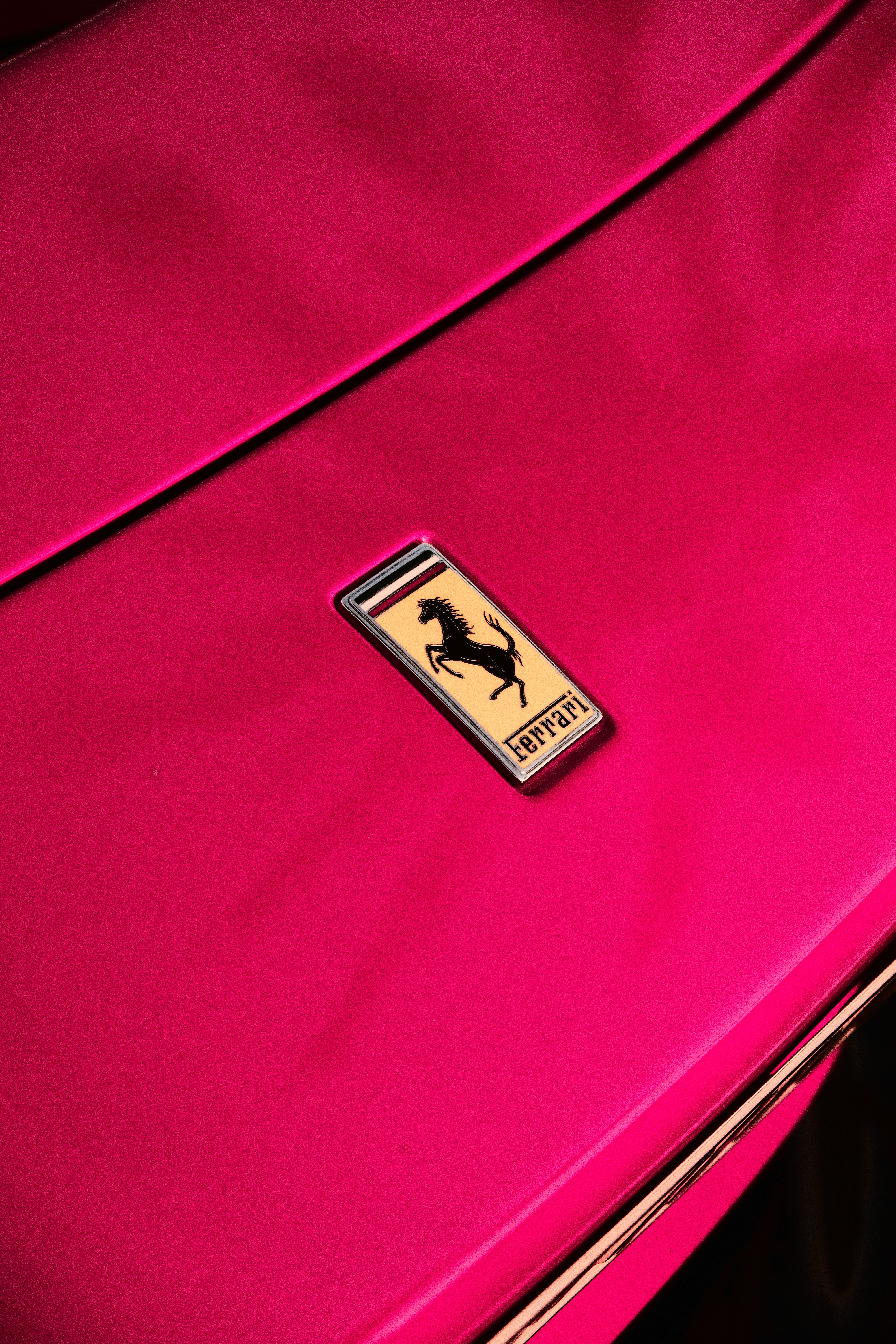 Vibrant Ferrari Badge on Luxurious Pink Car · Free Stock Photo