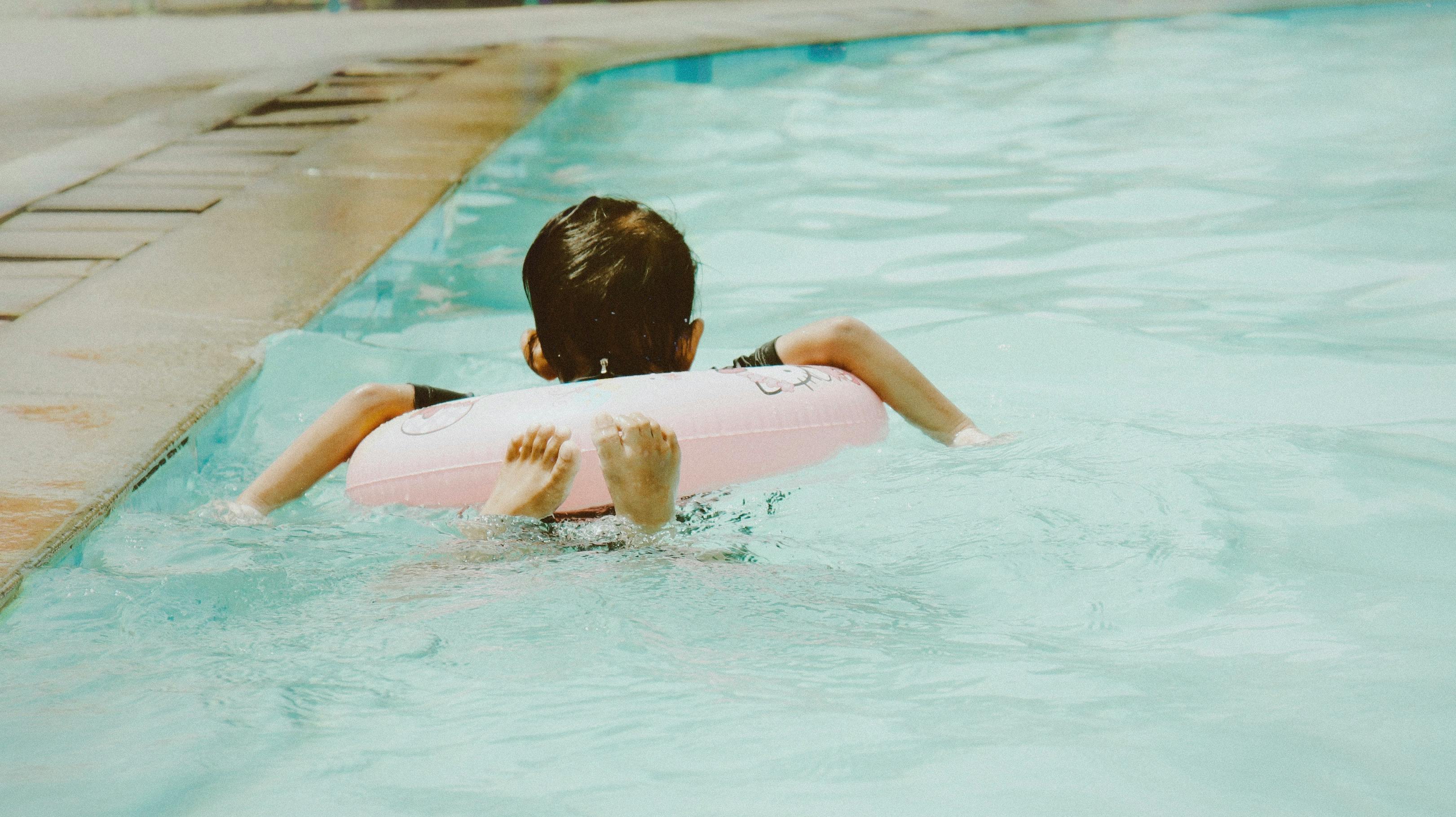 Child Falling into Swimming Pool on Back · Free Stock Photo