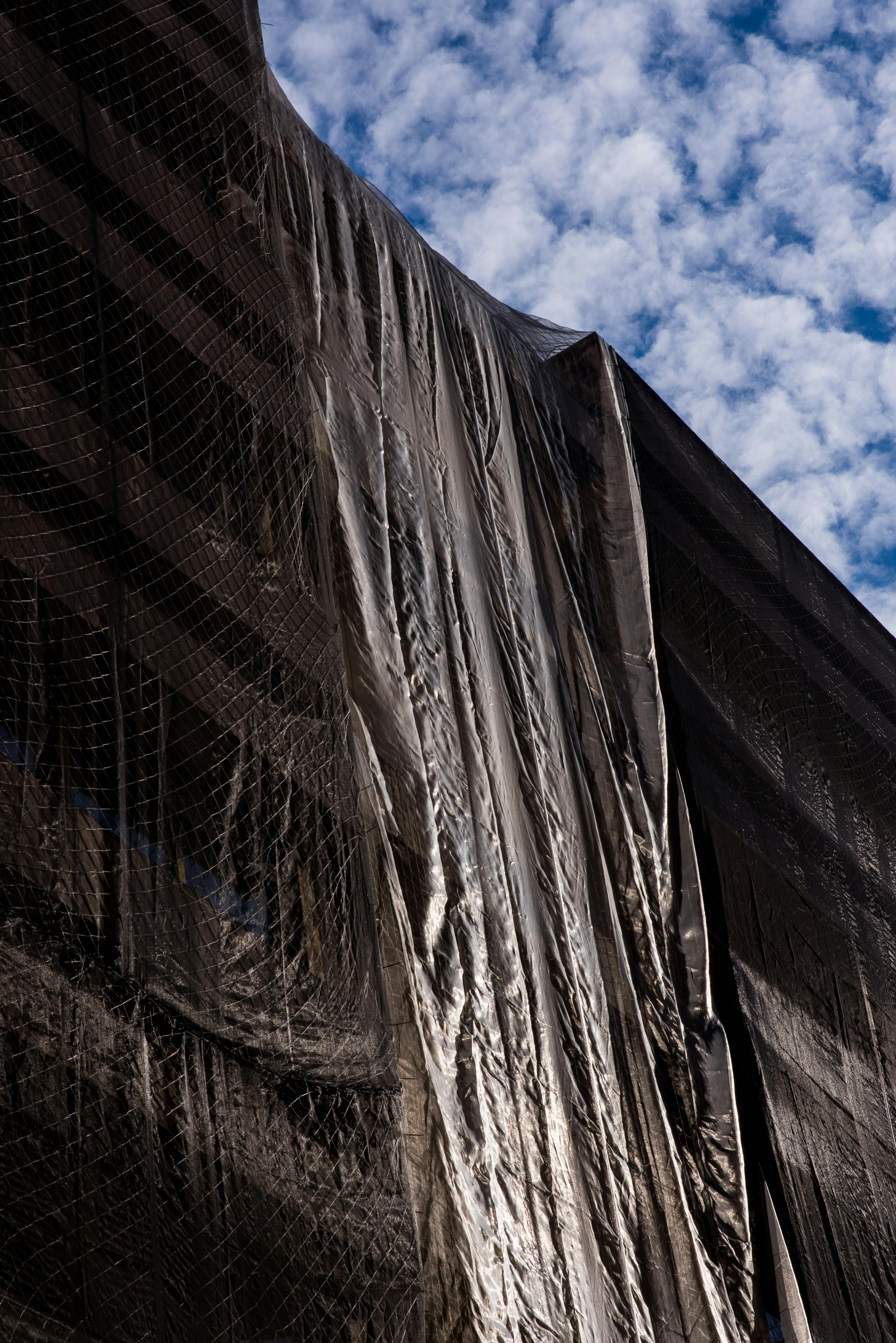 Dramatic Building Under Construction Against Clouds · Free Stock Photo