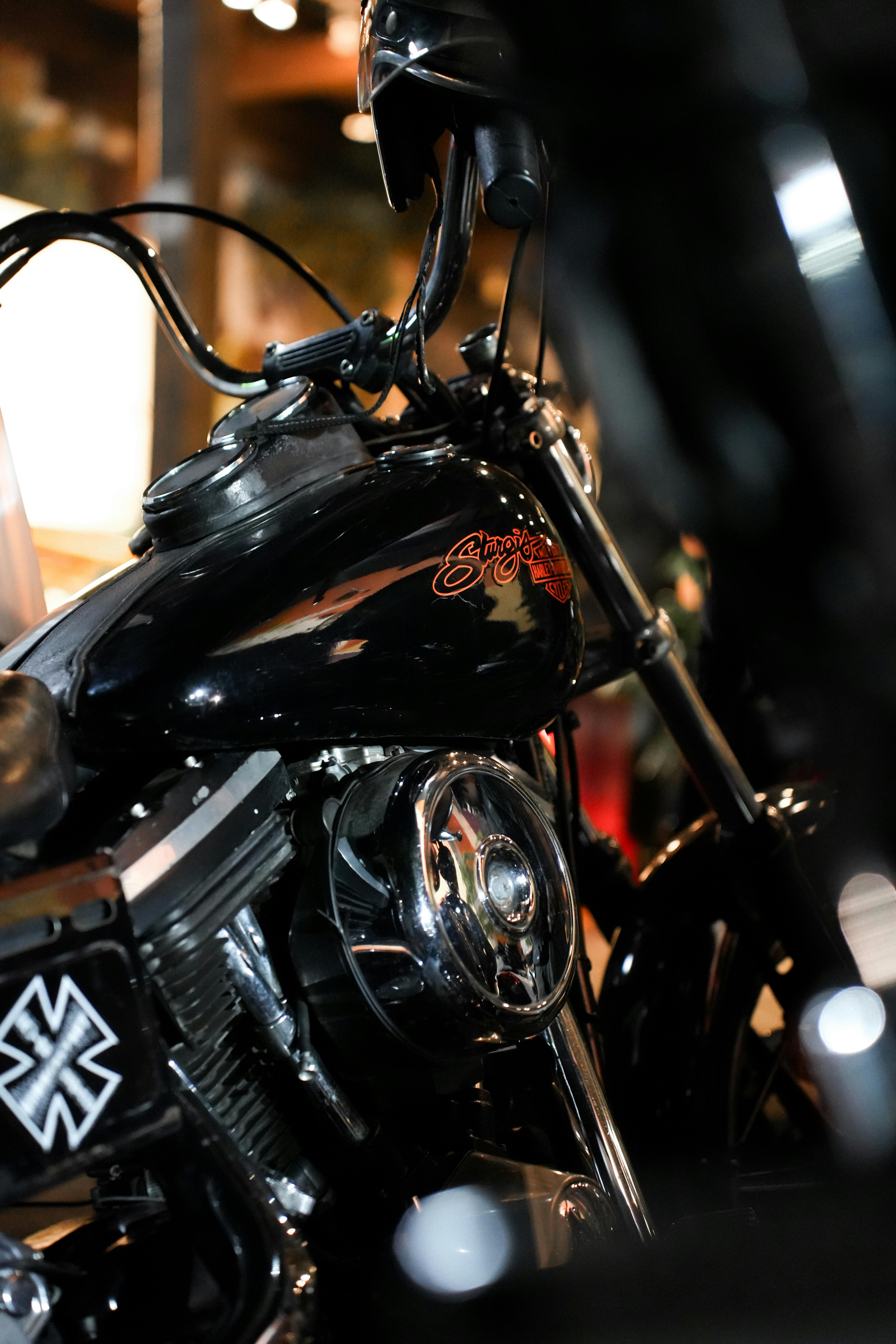 Close-up of Vintage Black Motorcycle with Logo · Free Stock Photo
