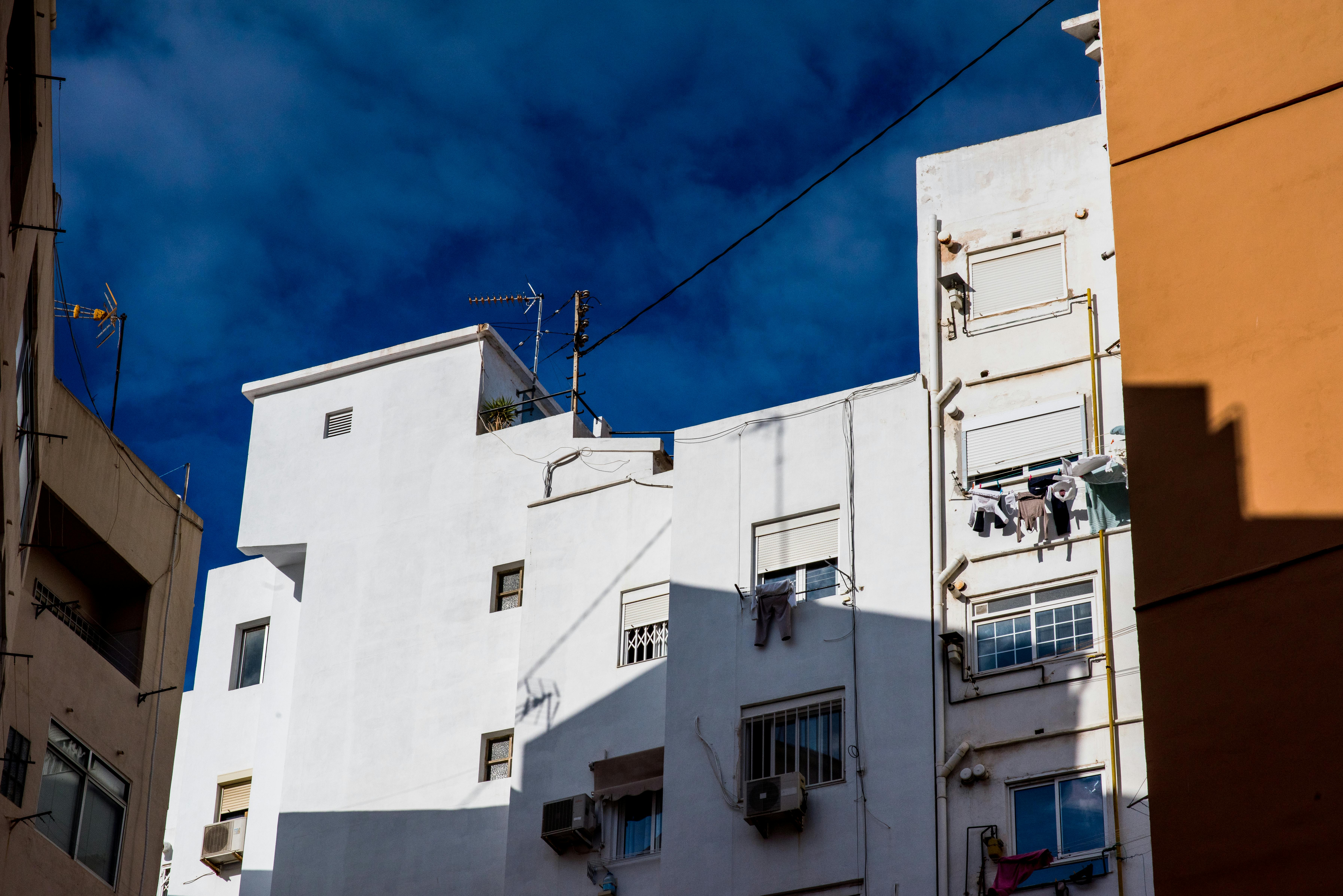 Urban Building Facades with Vibrant Blue Sky · Free Stock Photo